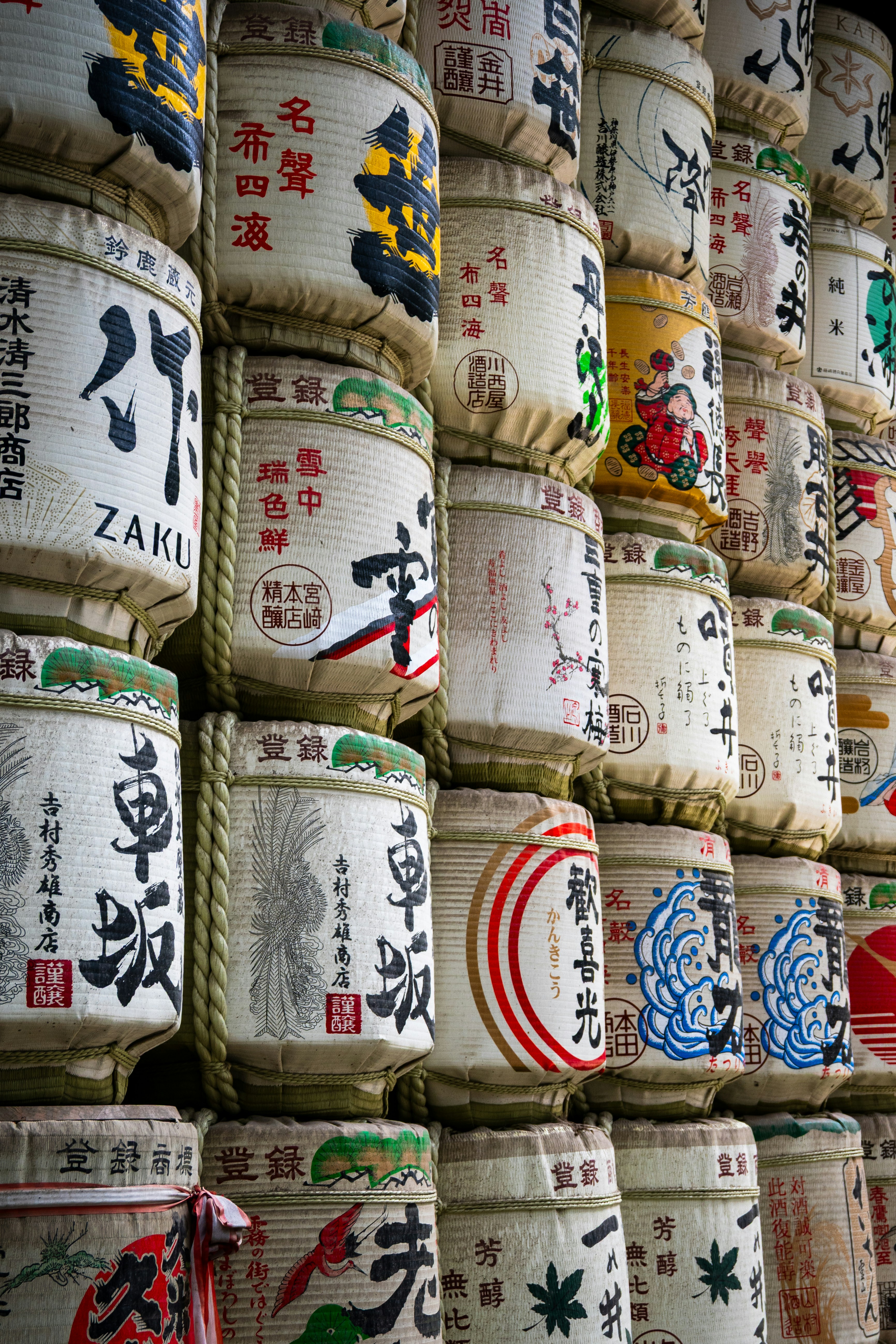 Row after row of sake barrels: a textile of labels and color