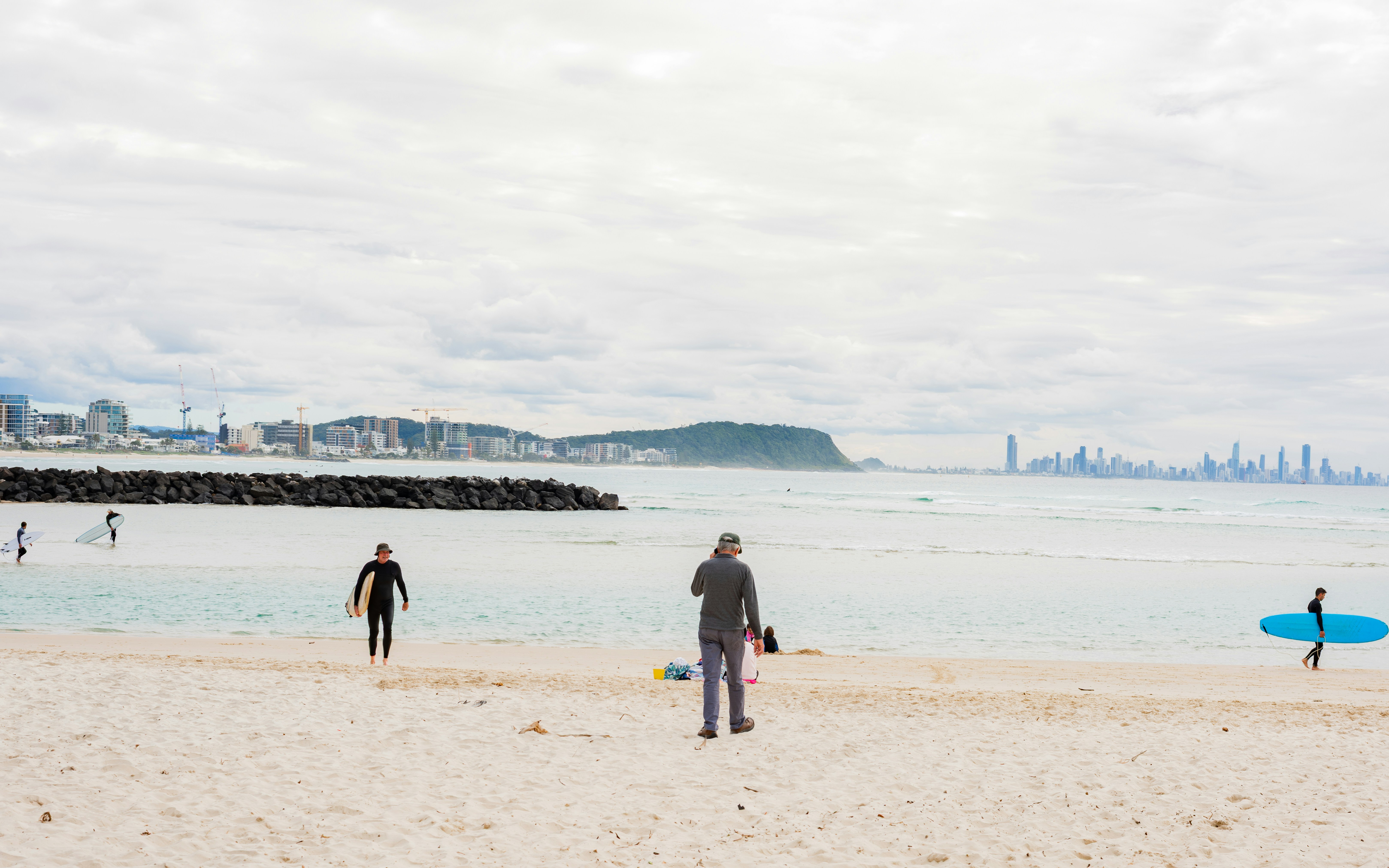 Twin Lifeguards: A Quiet Beach Morning with Surfers in the Distance