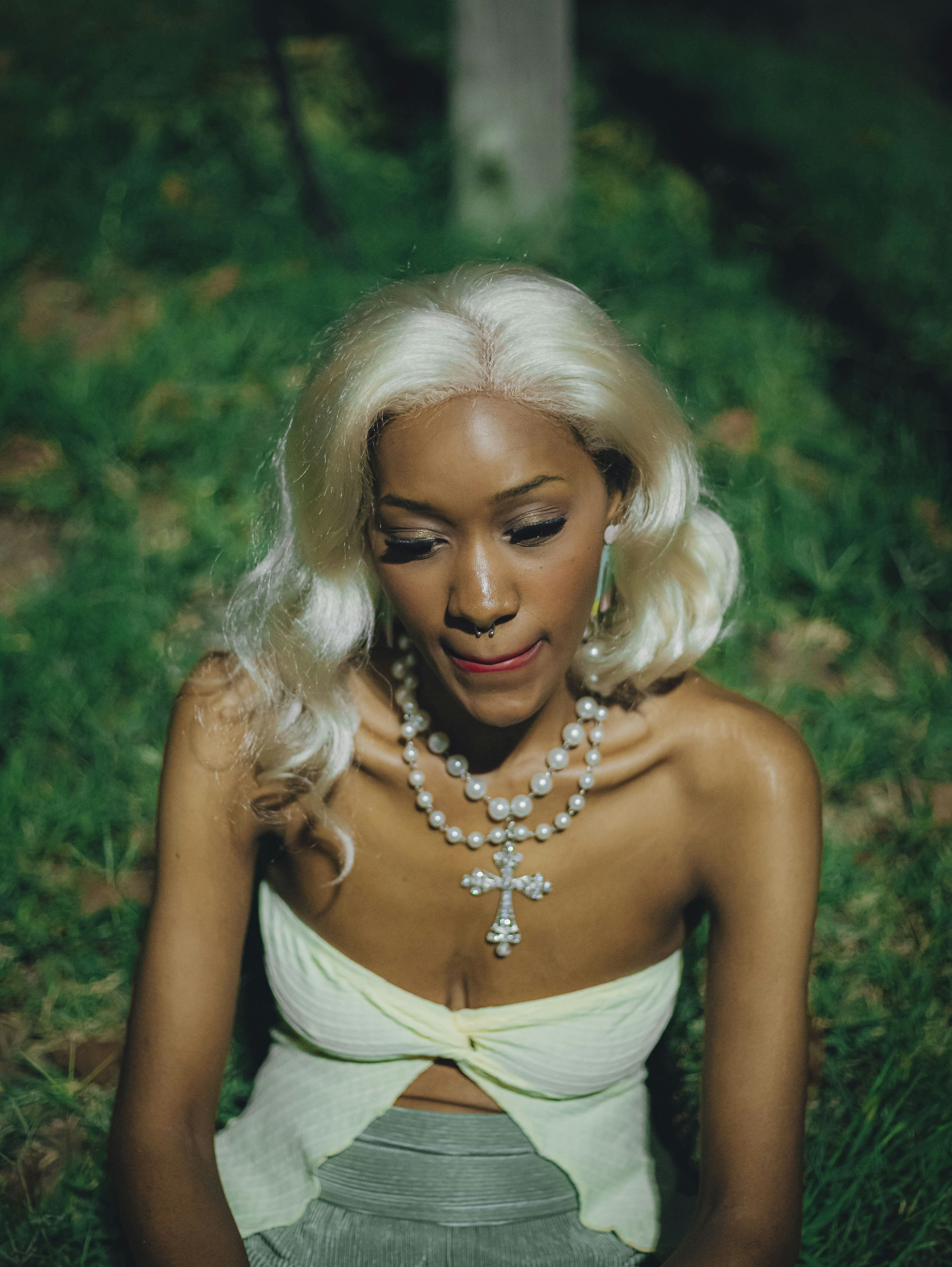 Pearl Necklace and Hidden Cross: A Quiet Moment in the Sunlit Clearing