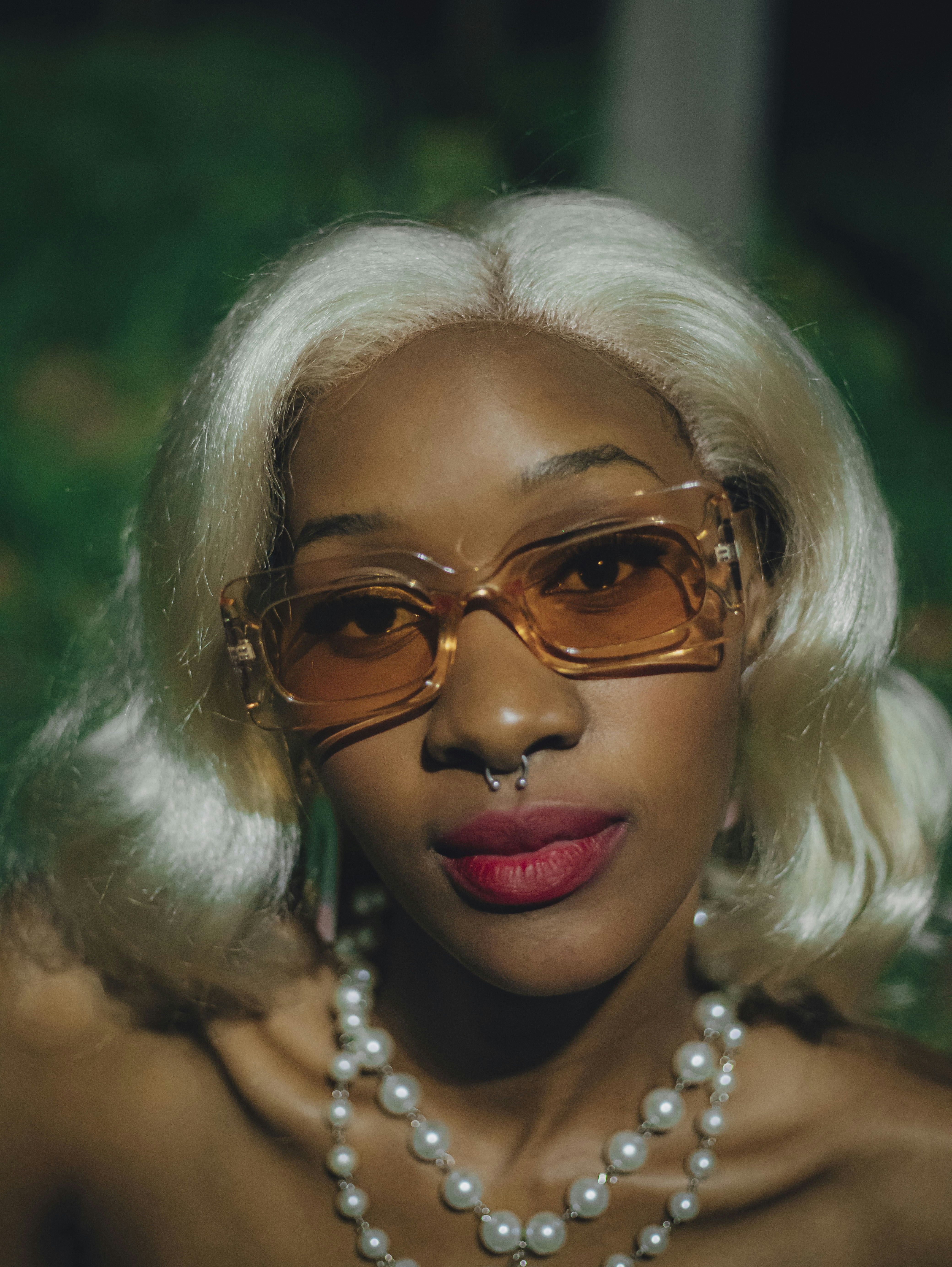 Golden Hour Glow: Bold eyewear and pearl confession