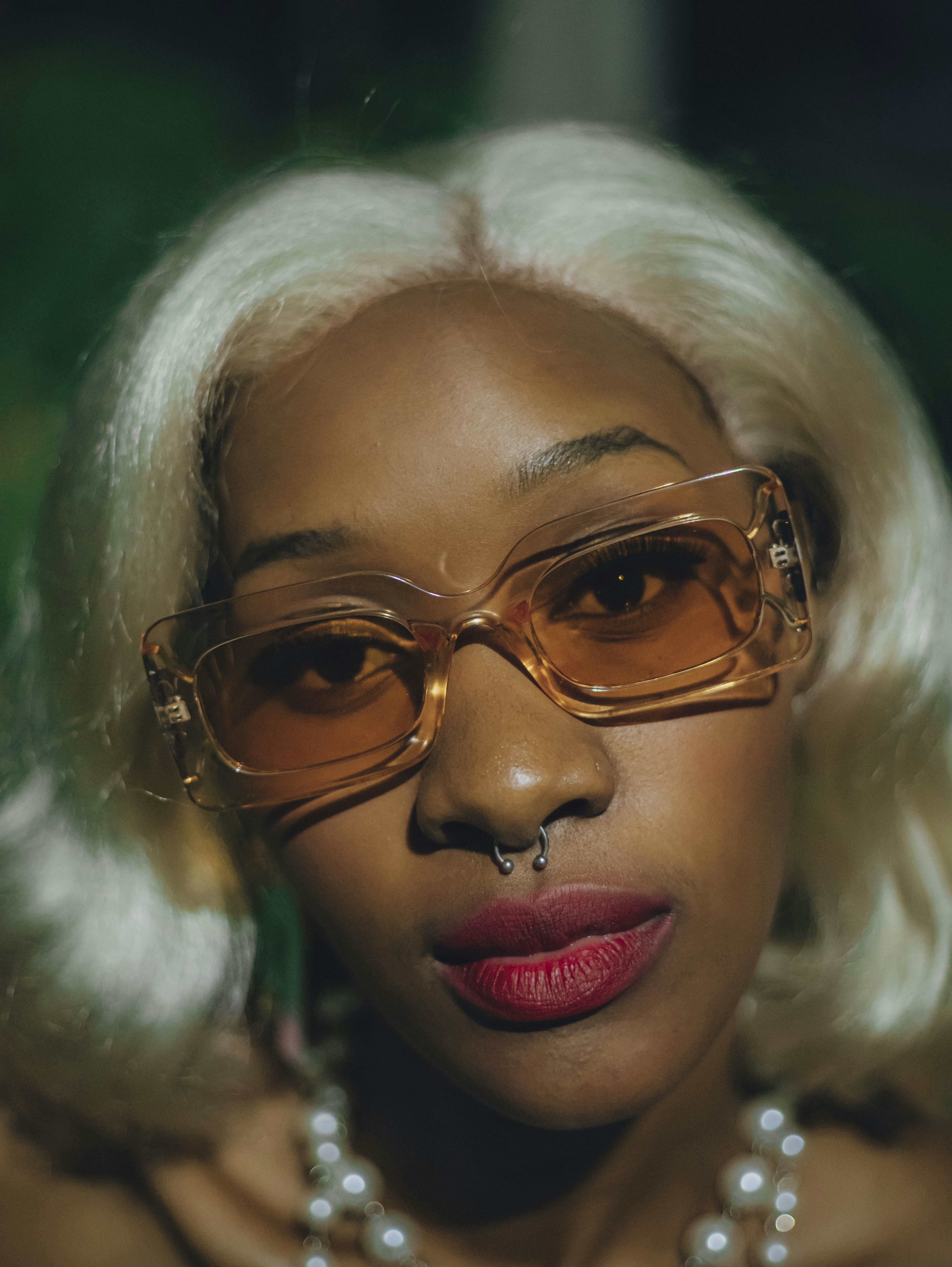Bold Glasses, Bold Eyes: A Close-Up Portrait in Neon Glow