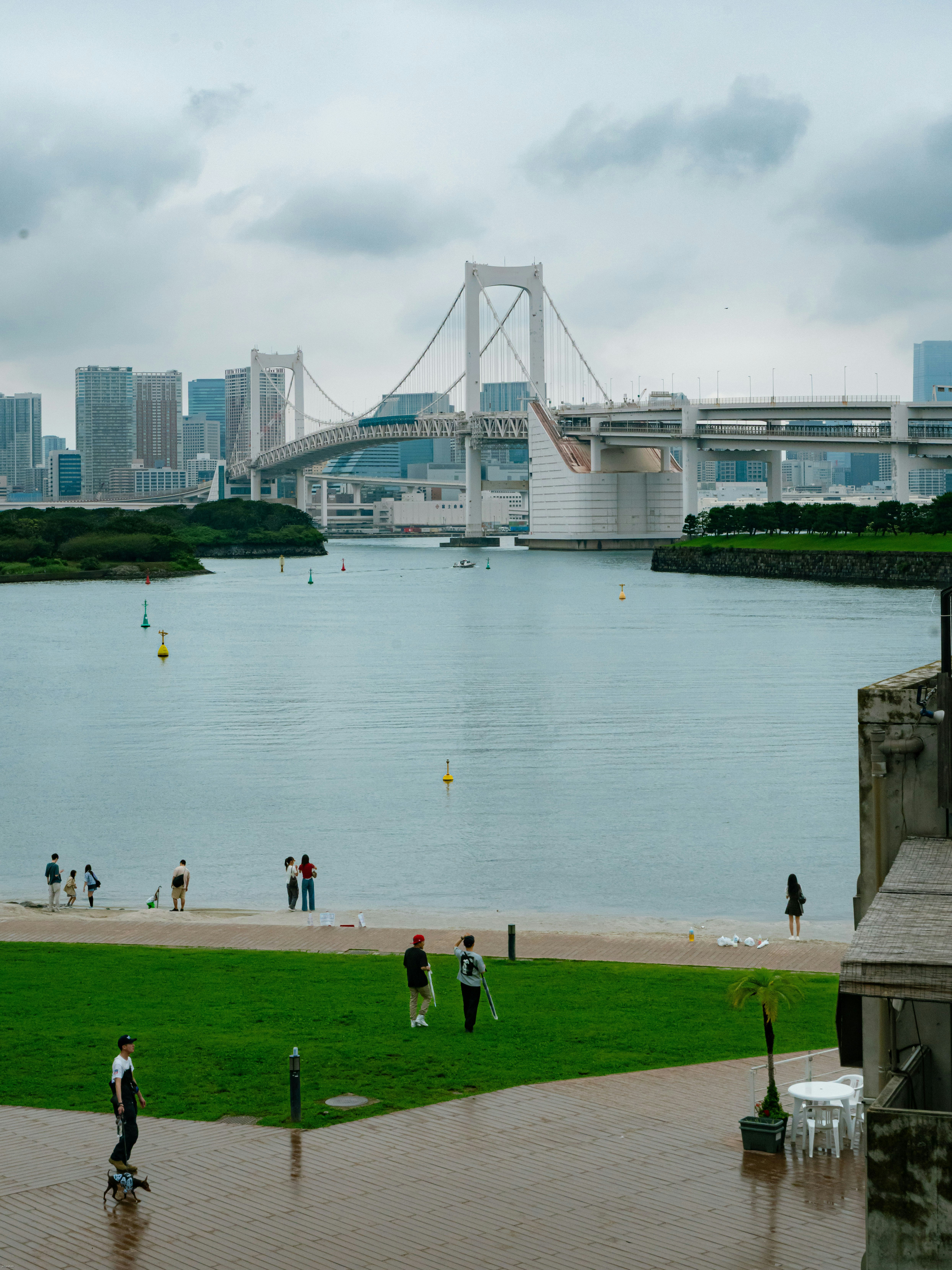 Cityscape by the Bridge: People at the Waterfront