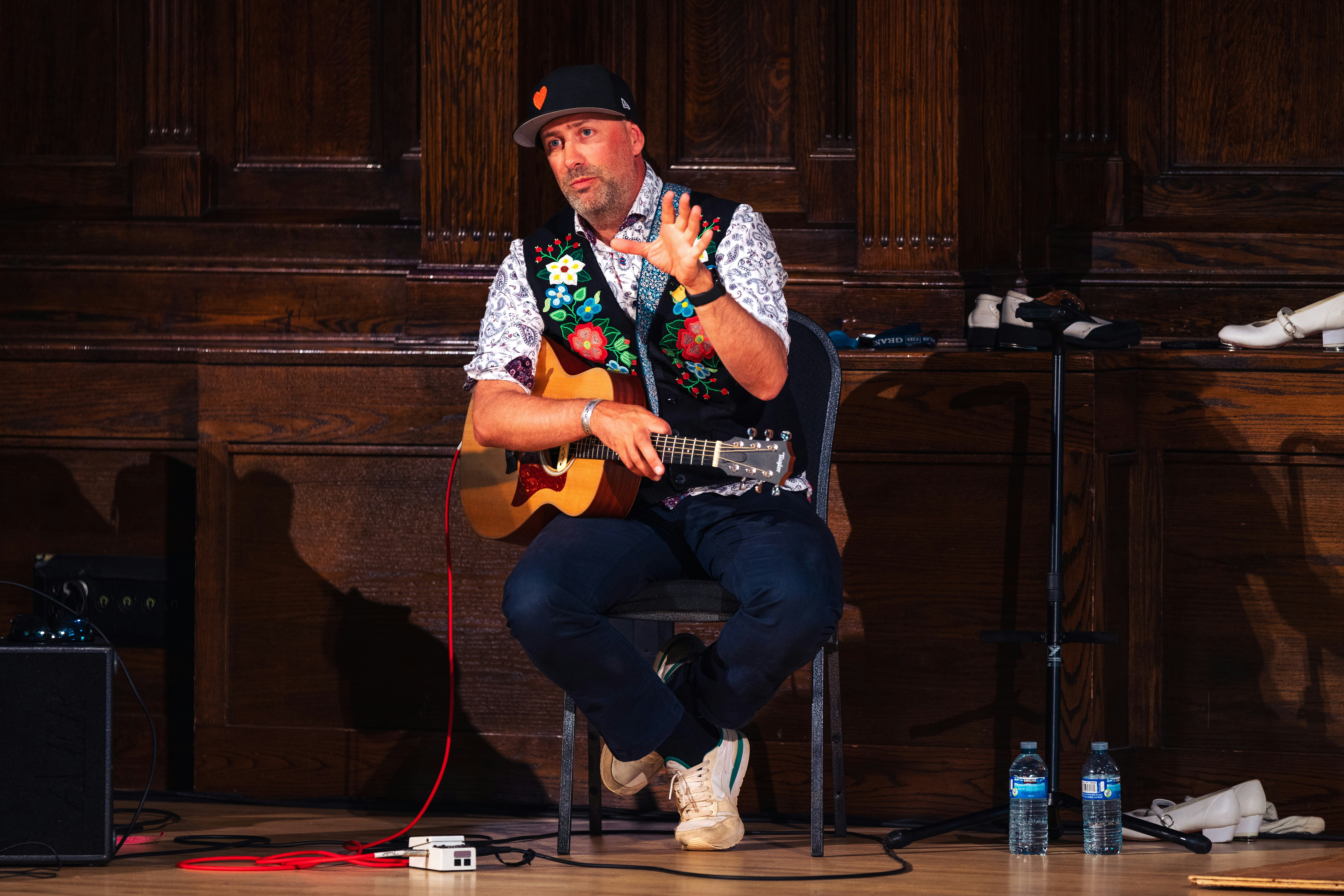 Guitarist on a Wooden Stage: A Vivid Solo Performance