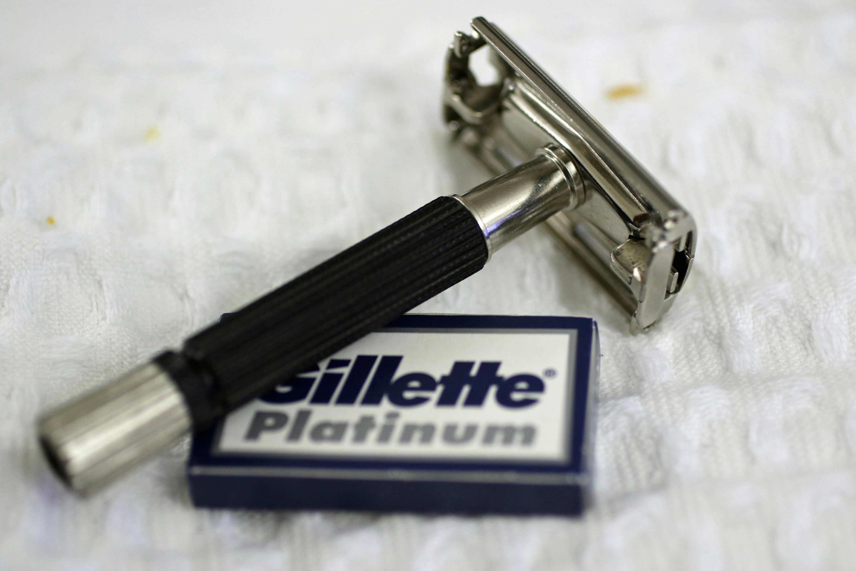 Close Shave: A Razor Resting Above a Slim Gillette Placard