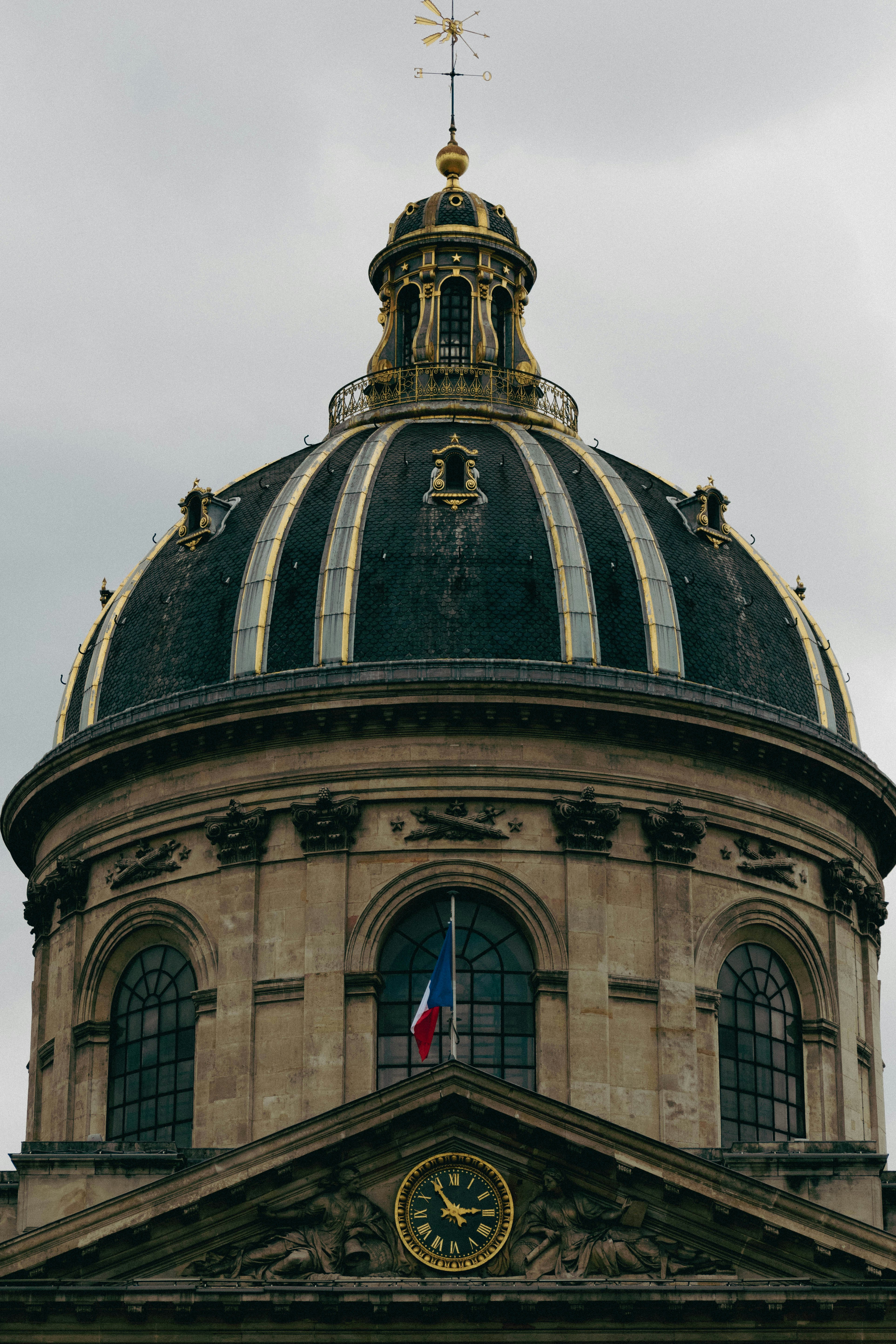 Dome of Authority: Parisian Clock and Flag Under Ornate Vault