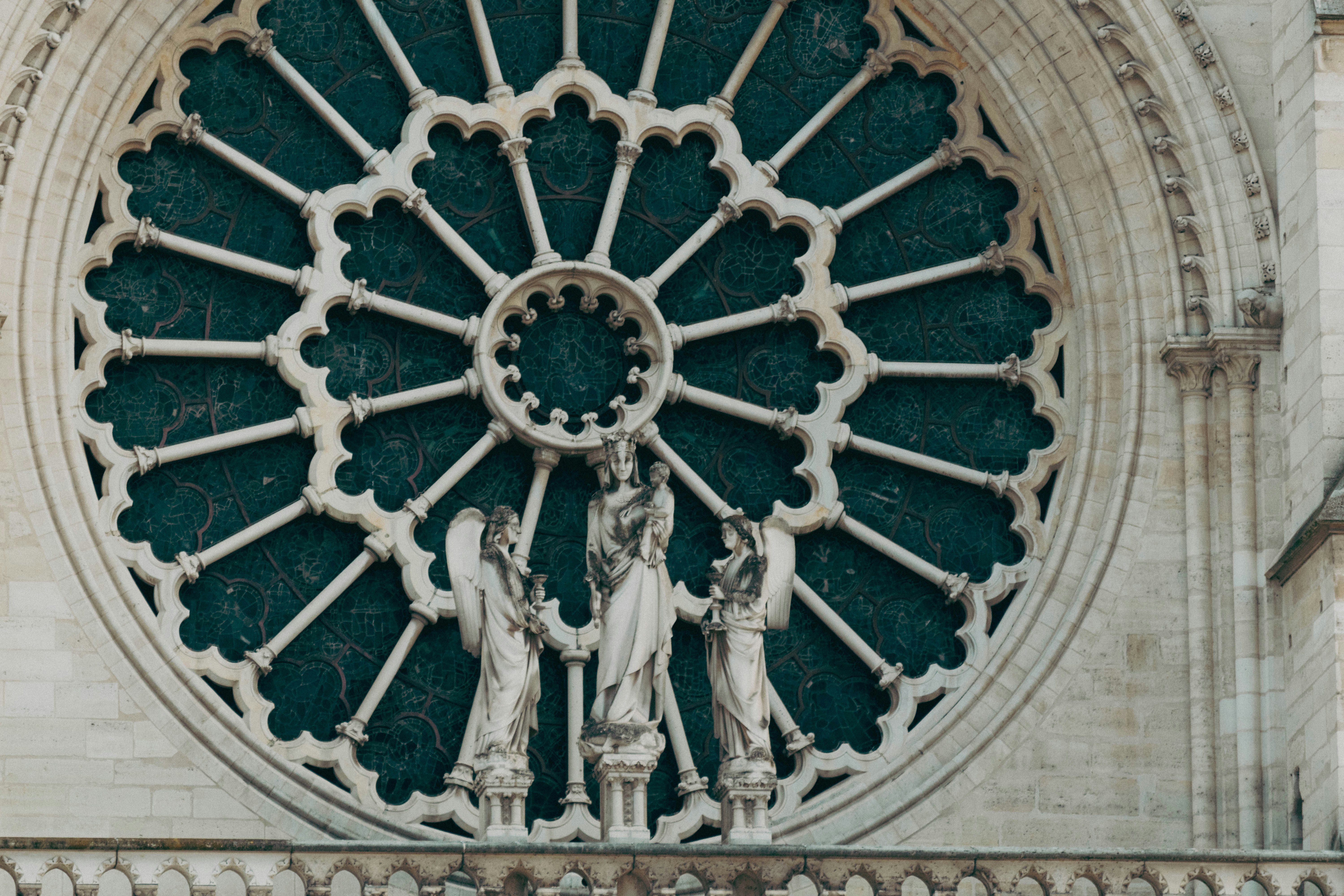 Rose Window Reverence: Statues Below the Circular Stained Glass