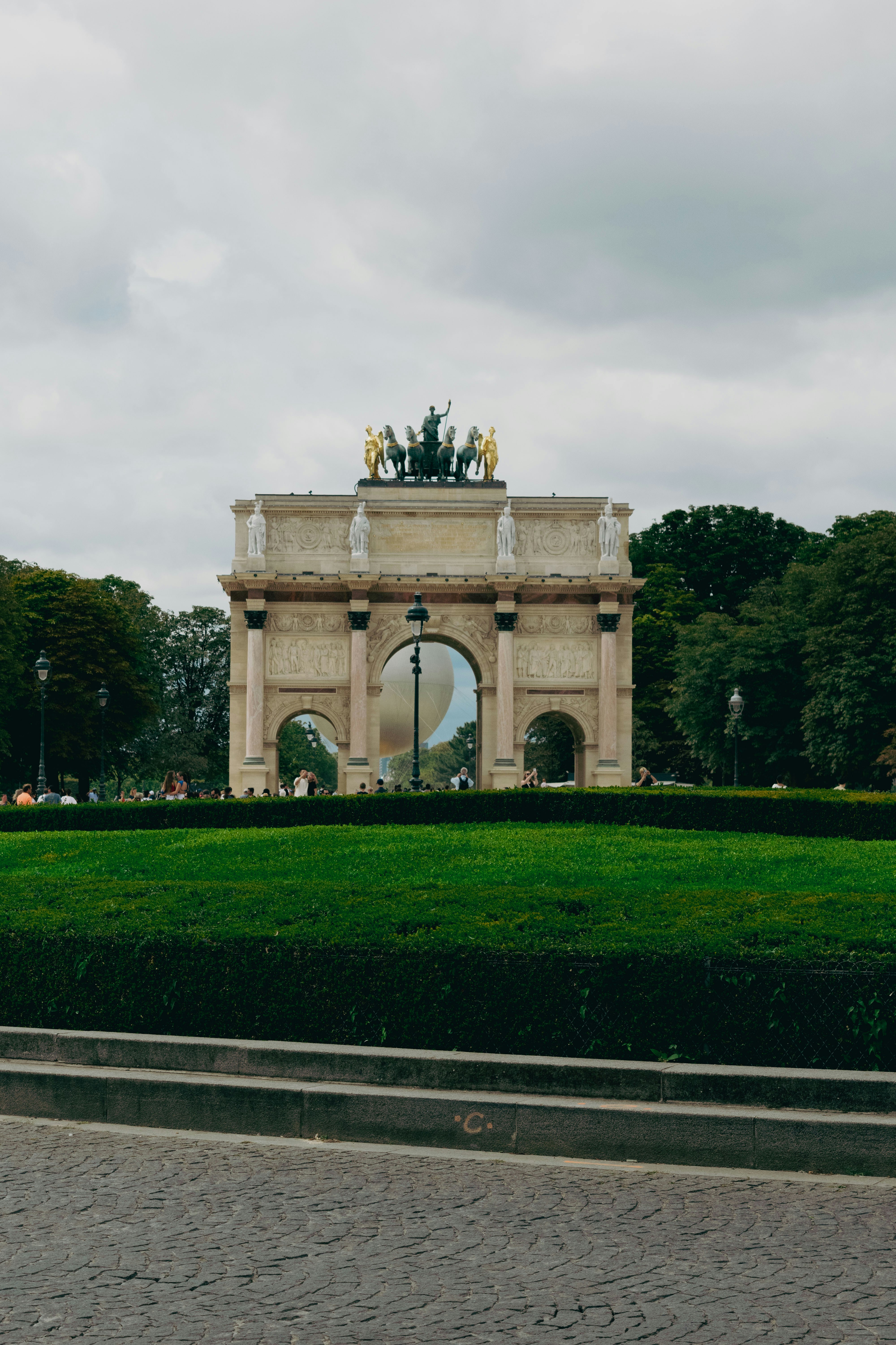 Arcade of Stone: The Triumphal Arch Framed by Velvet Green