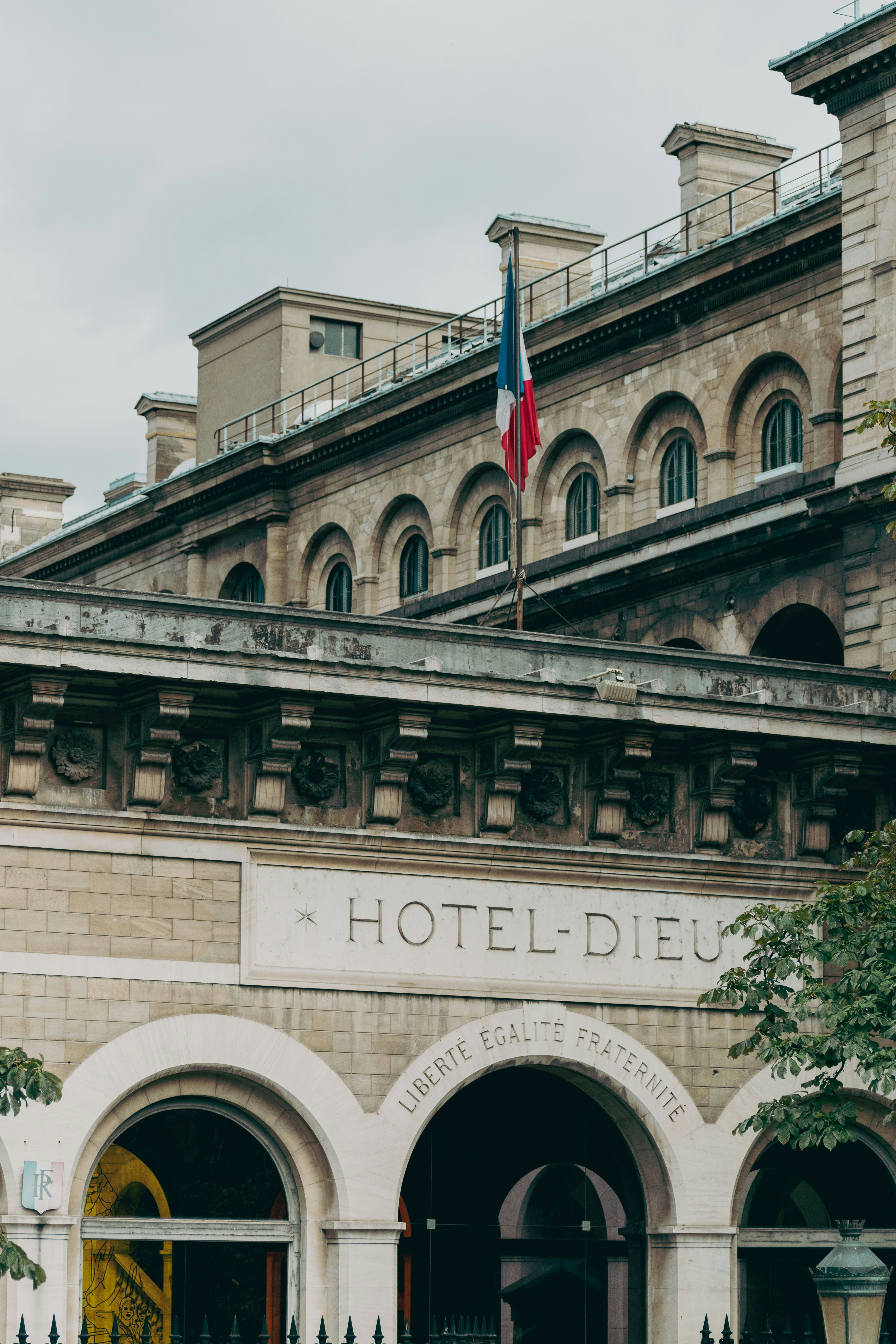 Facade of a Parisian Hotel-Dieu with a Flag Overhead