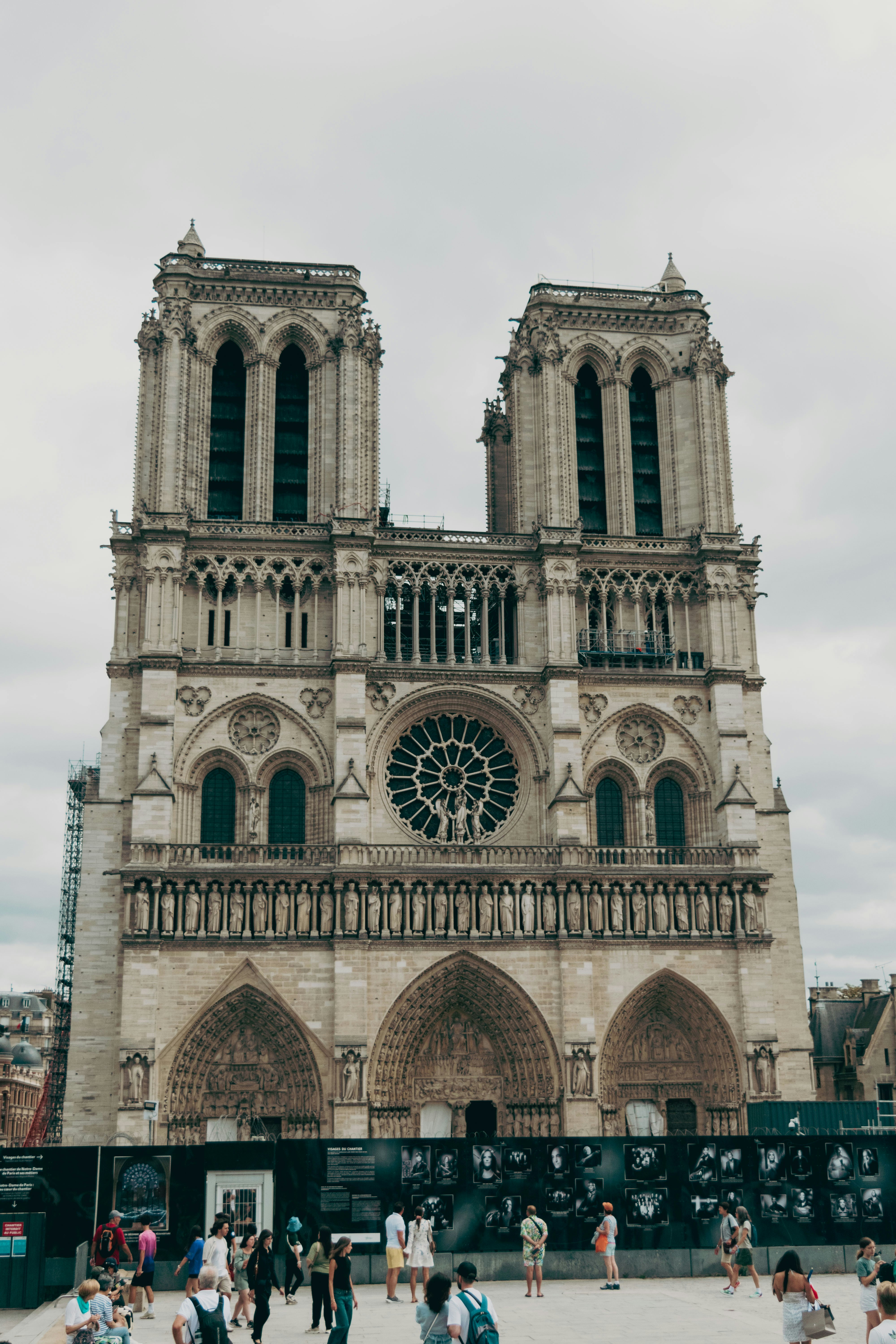 Gothic Grandeur: Notre-Dame's Facade Framed by a Courtyard of Visitors