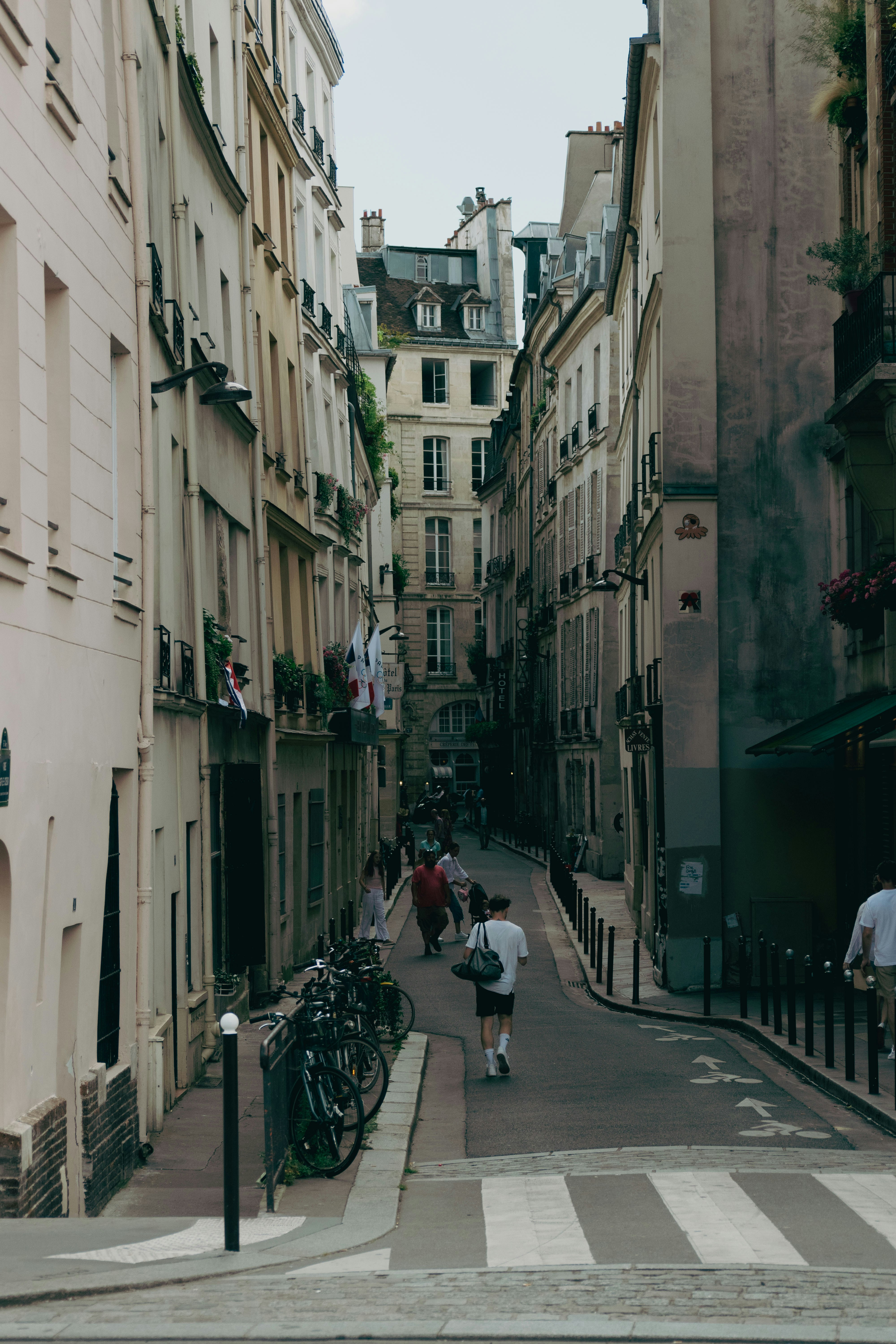 Narrow Parisian Alleyway: Daylight Pours Between Historic Facades