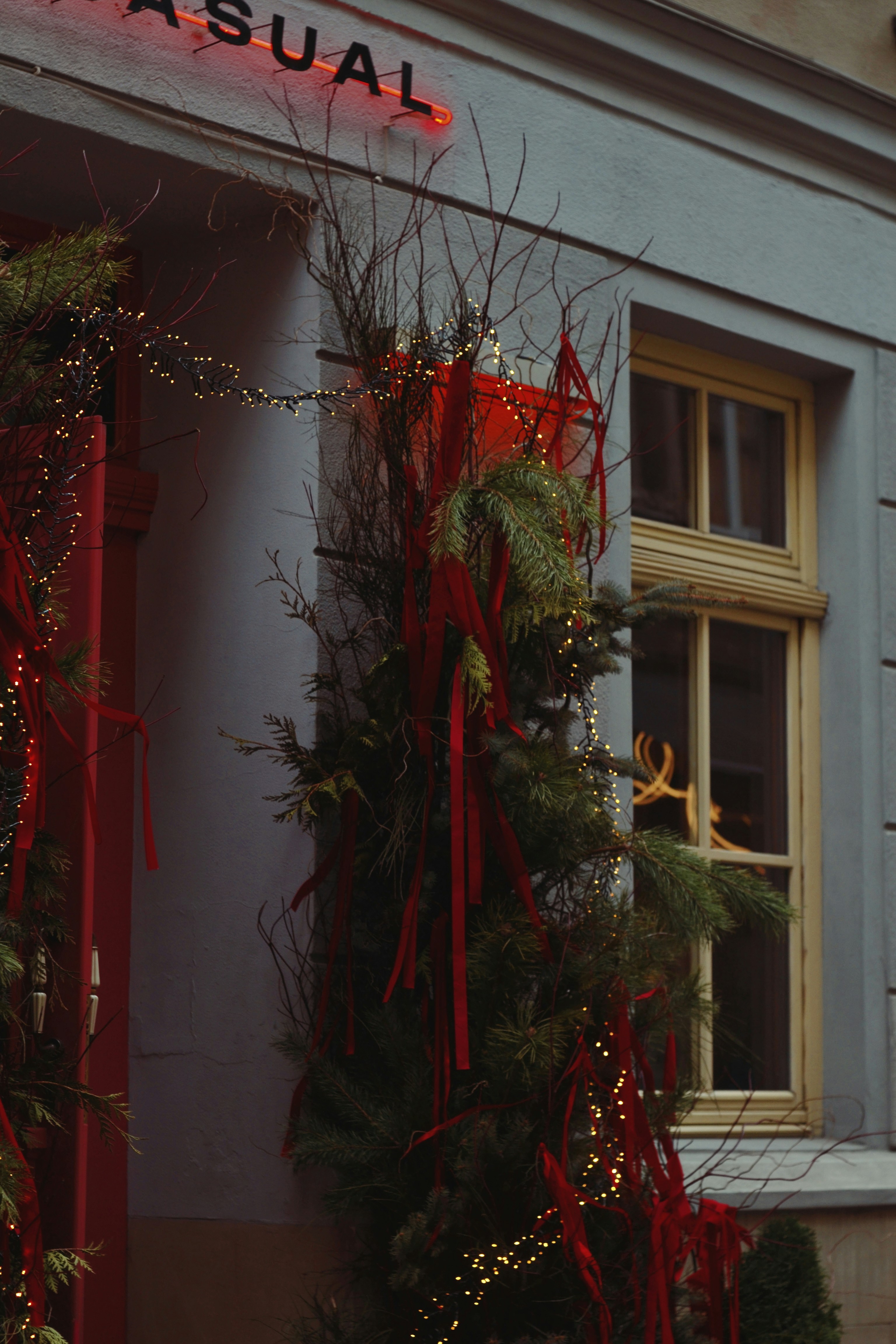 Red Ribboned Window Frame: A Festive Facade
