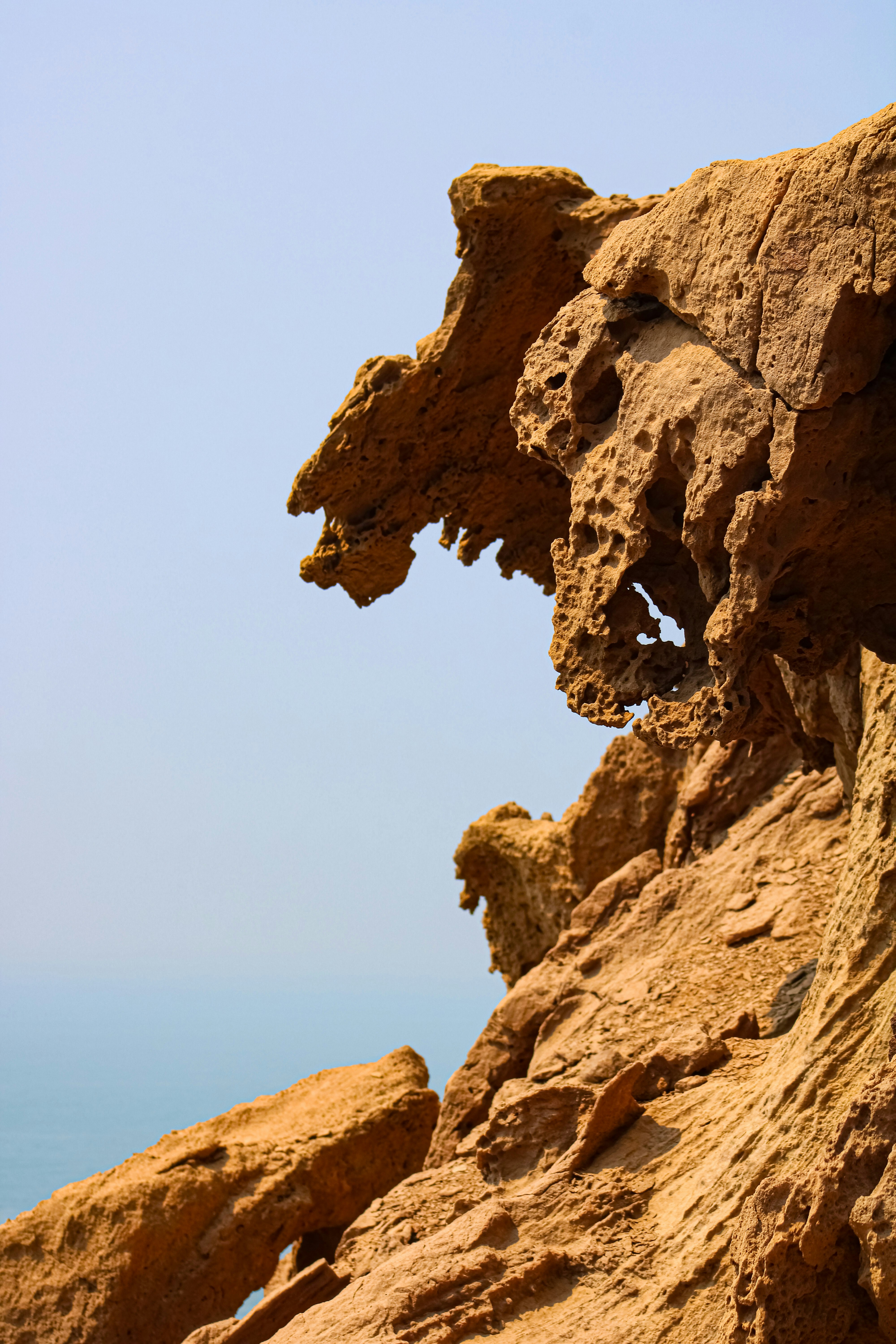 Stone Dragon on the Cliff: Eroded Formations Beneath a Clear Sky