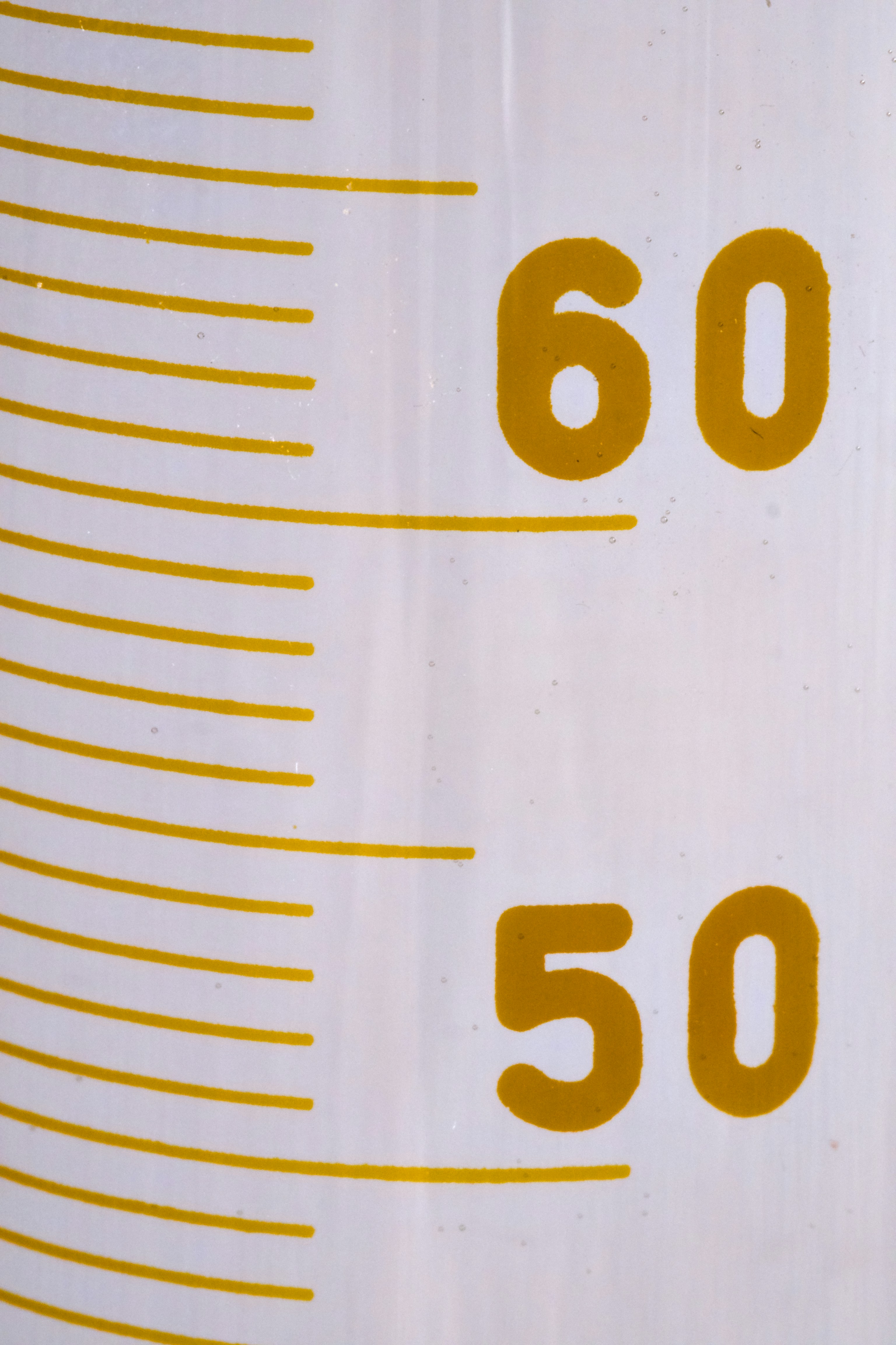 Close-up of a Measuring Scale: Golden Numbers on White Background