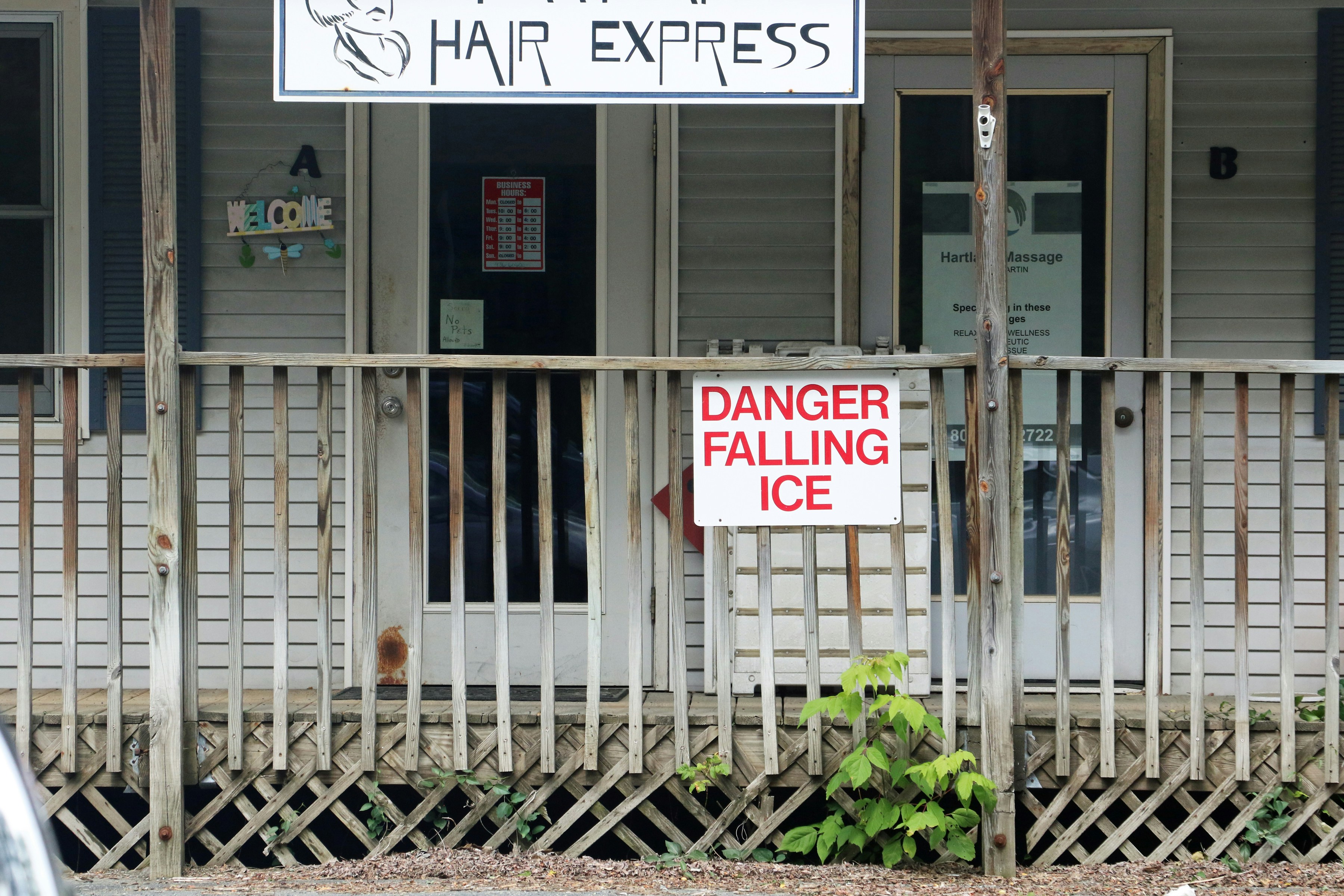 Faded Frontage, Warning Sign, and Cedar Rail: A Quiet Post-Industrial Shopfront