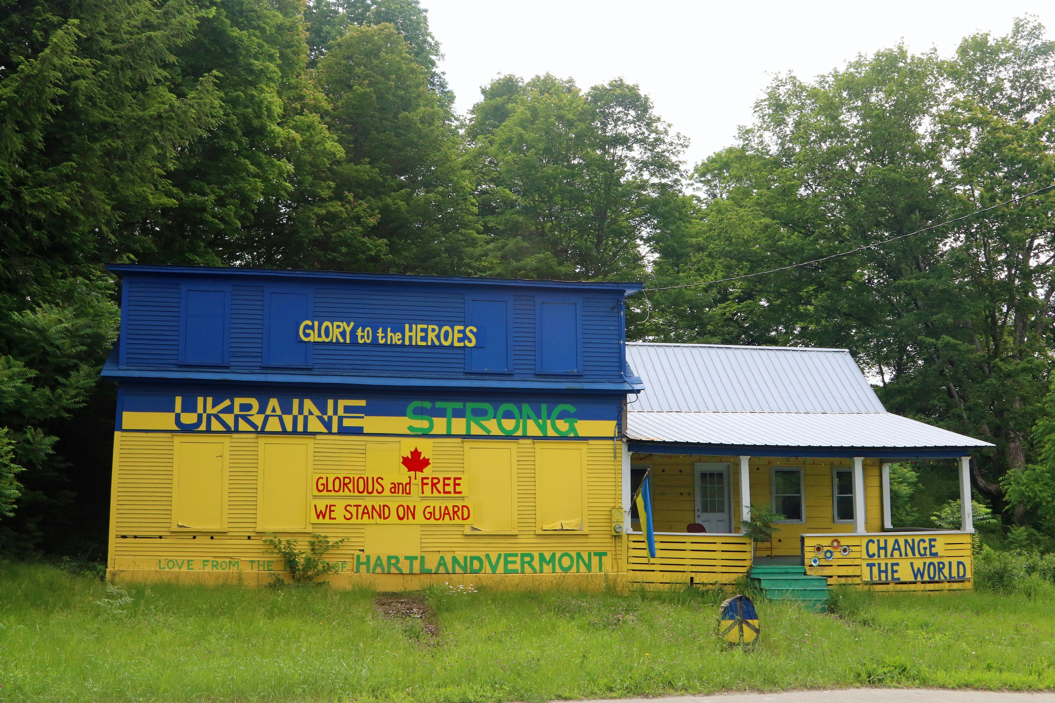 Colorful Bannered Cabin: A Village Message in Primary Blue and Yellow