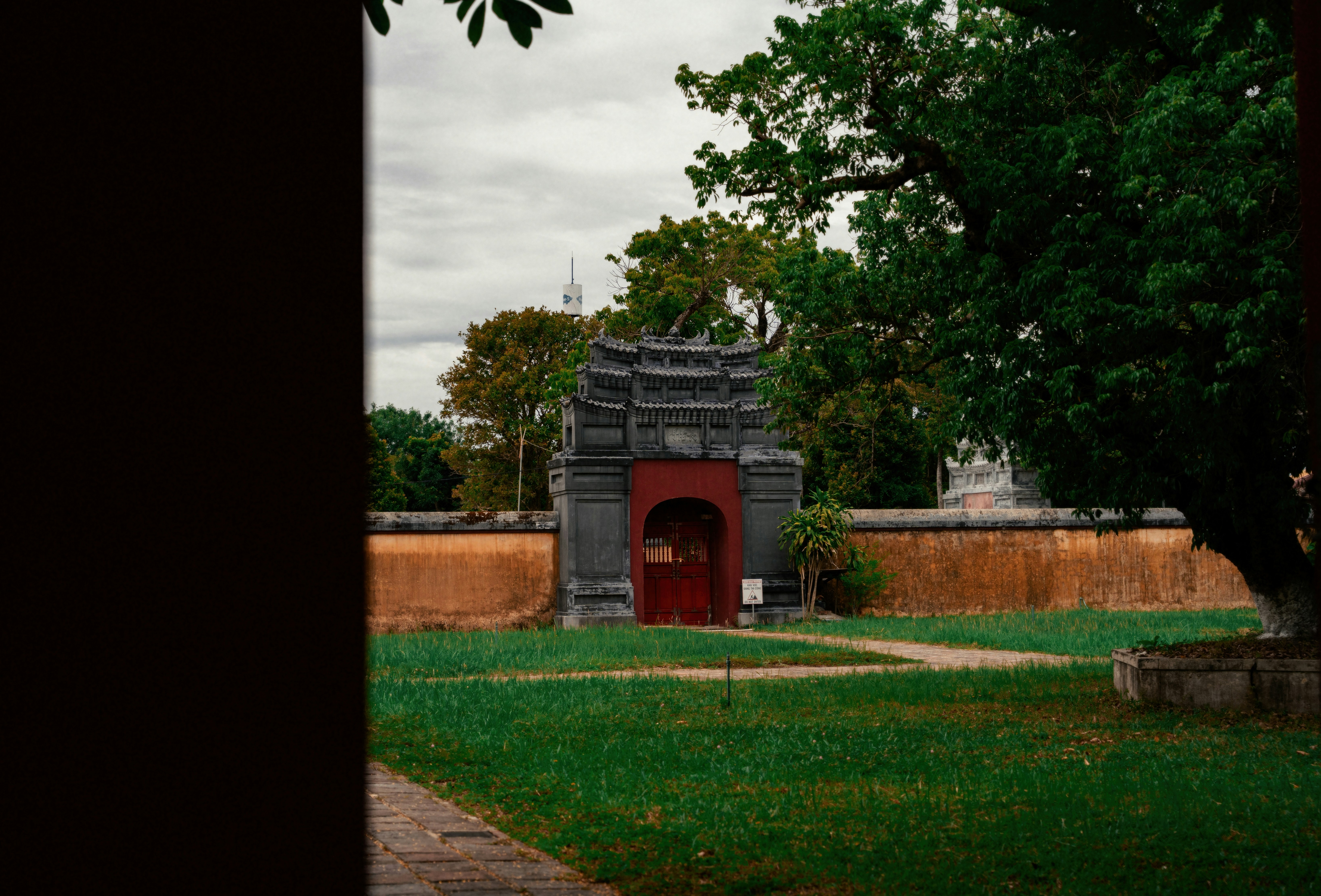 Gatehouse in a Green Courtyard Framed by Shade