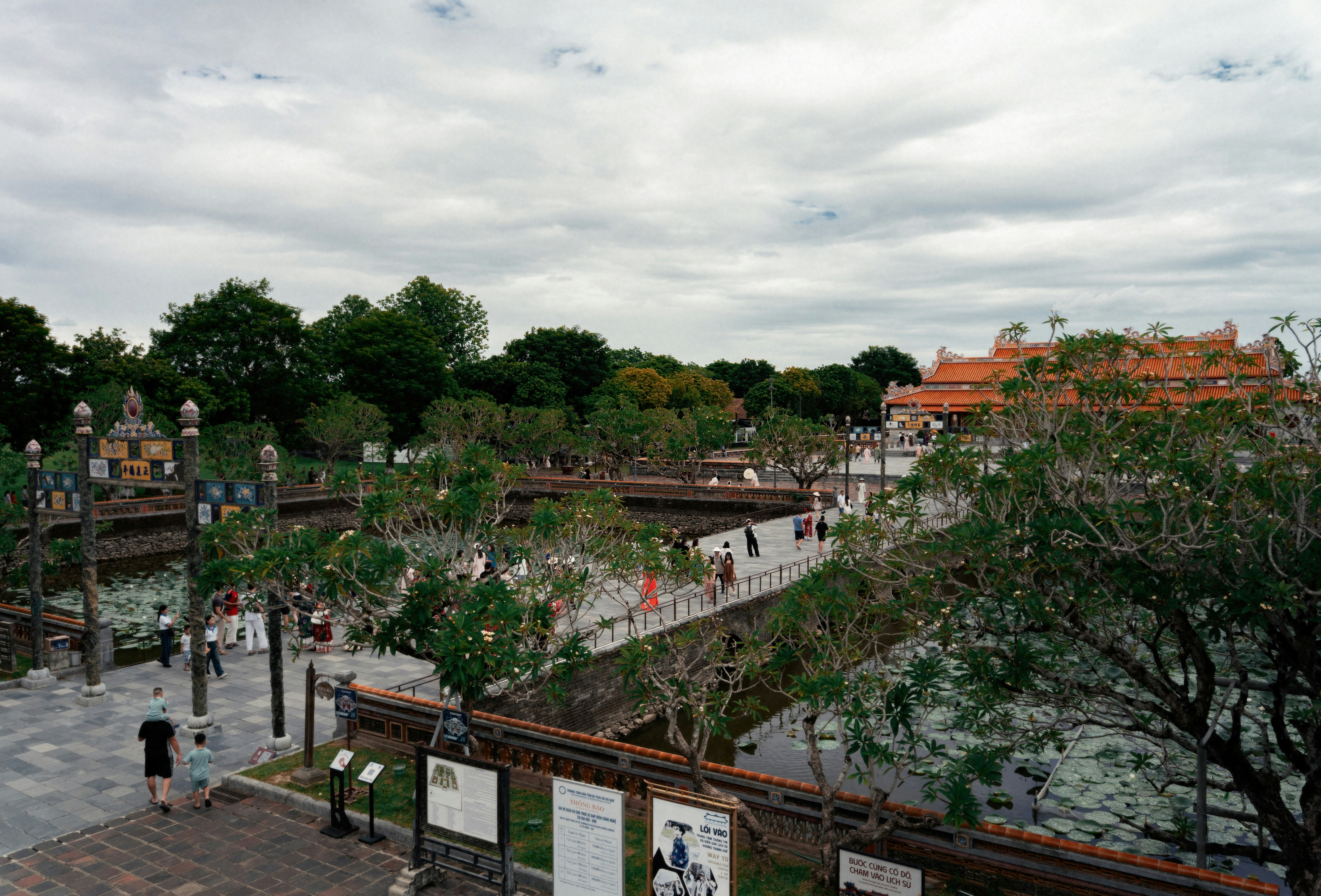 Temple Courtyard Vista: Pathways, Lanterns, and a Rooftop Golden Temple