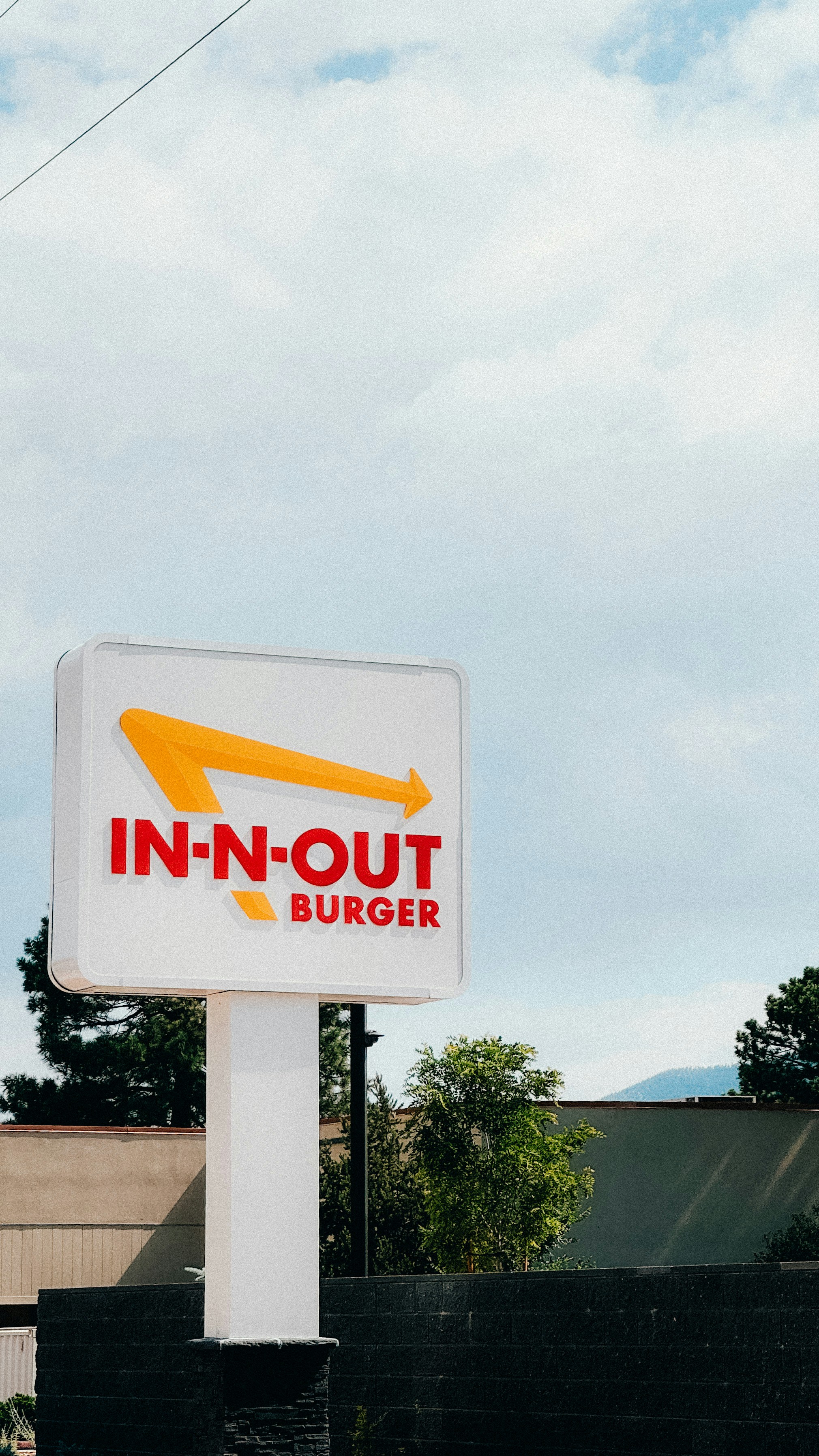Signpost of Flavor: In-N-Out Burger under a Wide Sky