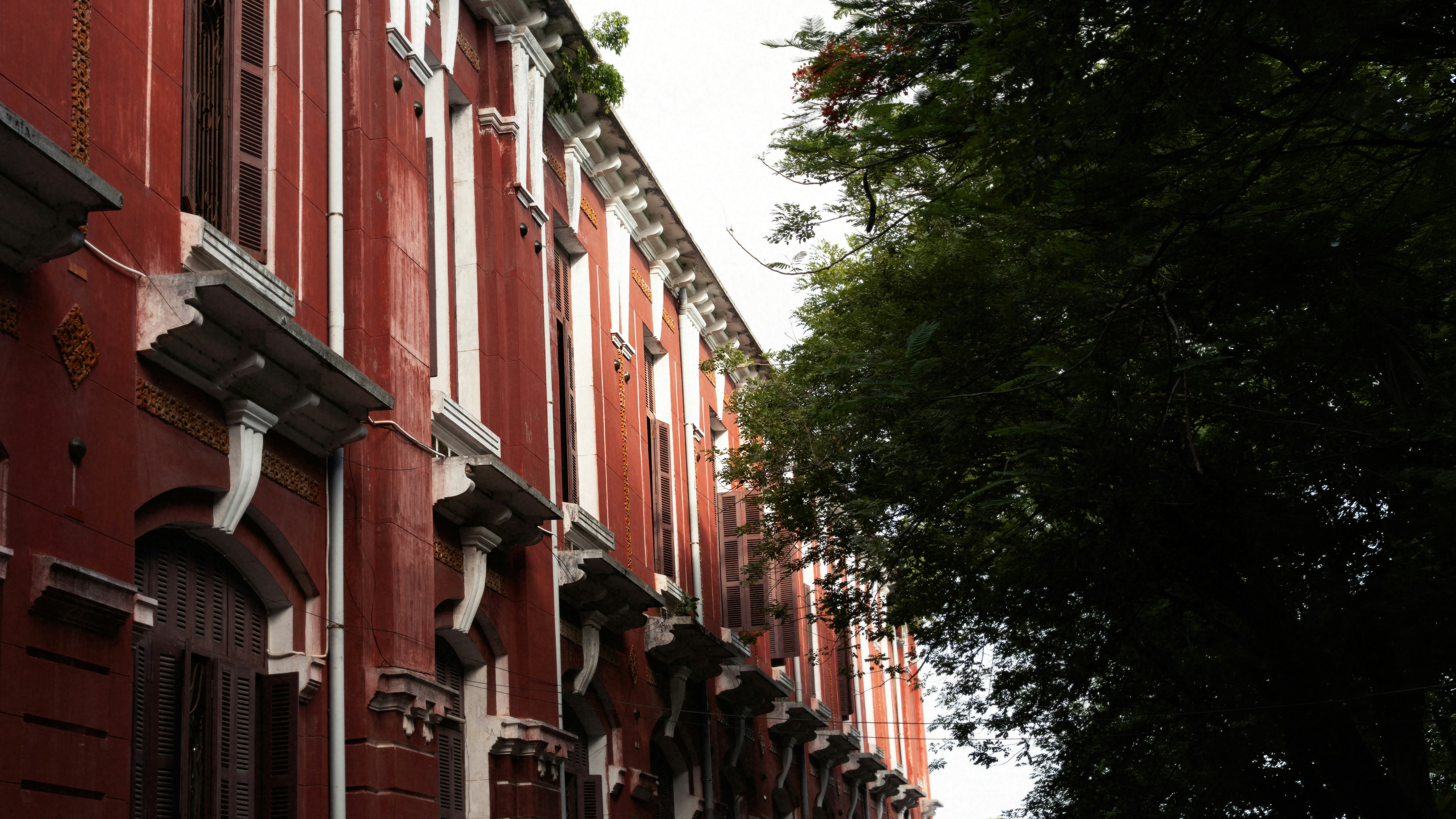 Red Facade and Shade: A City Block in Quiet Sunset Light