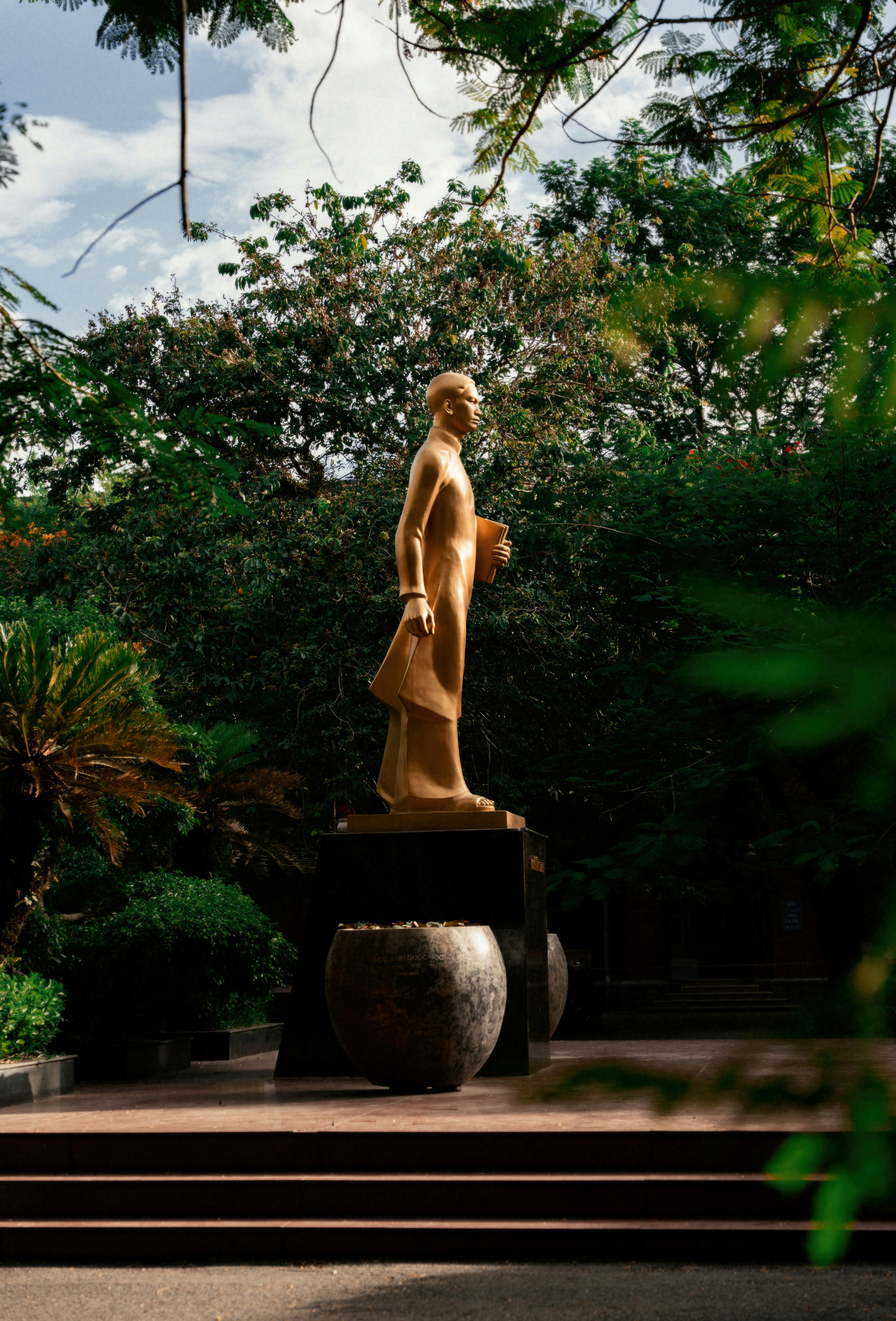Statue in Quiet Garden: A Bronze Figure Amid Greenery