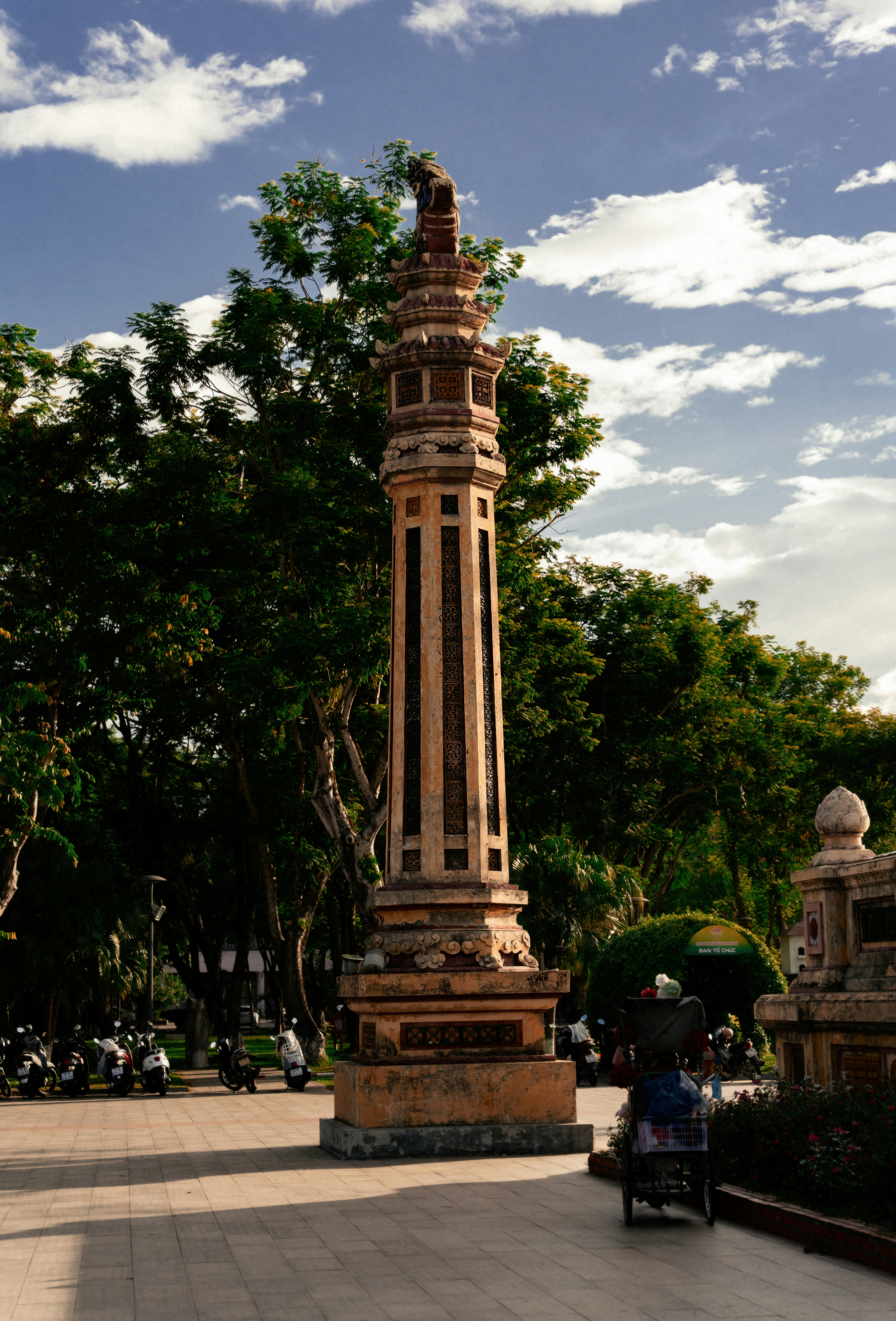 Stone Spire Rising over a Courtyard of Greenery