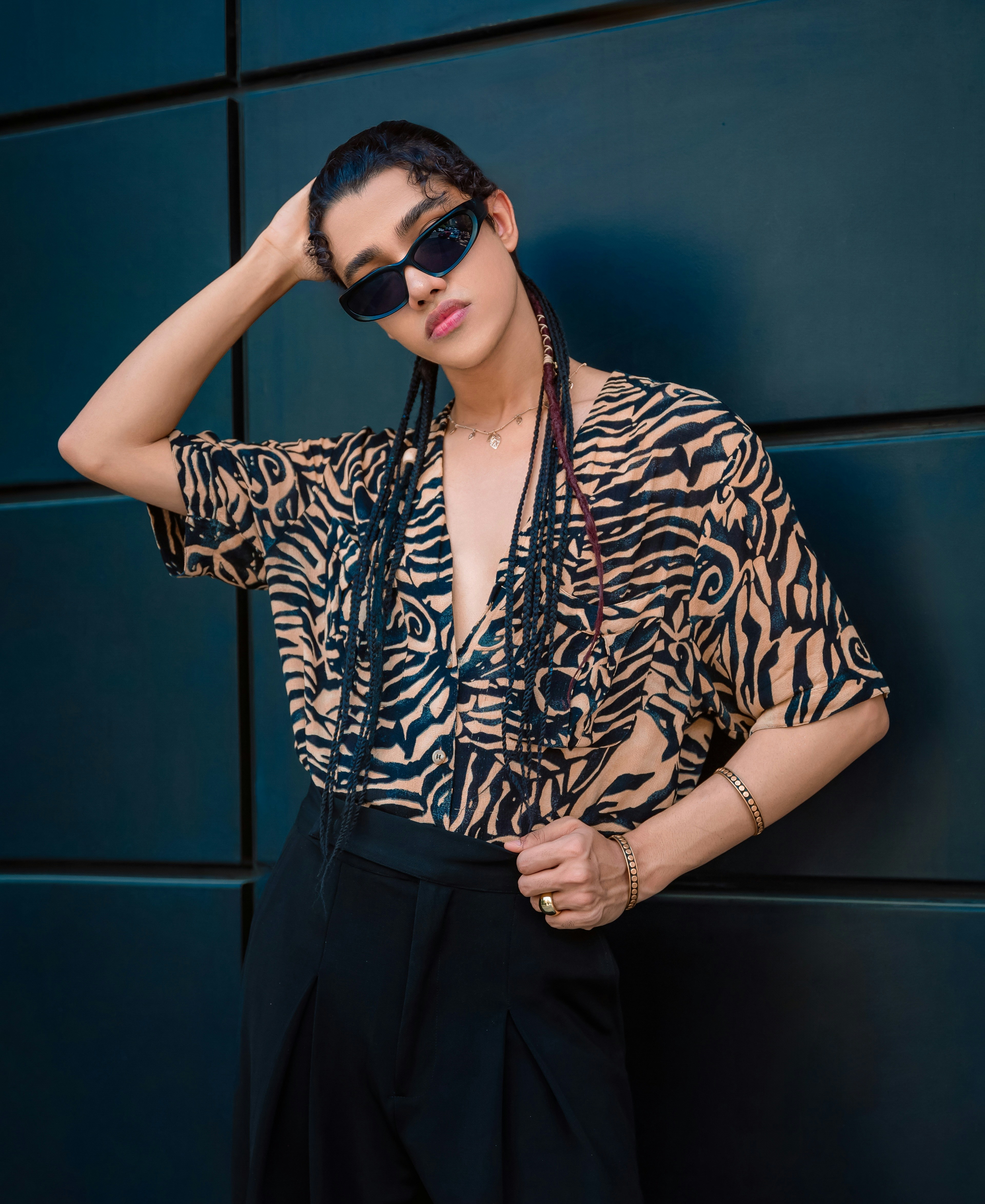Shadowed Chic: a bold portrait against a teal panel