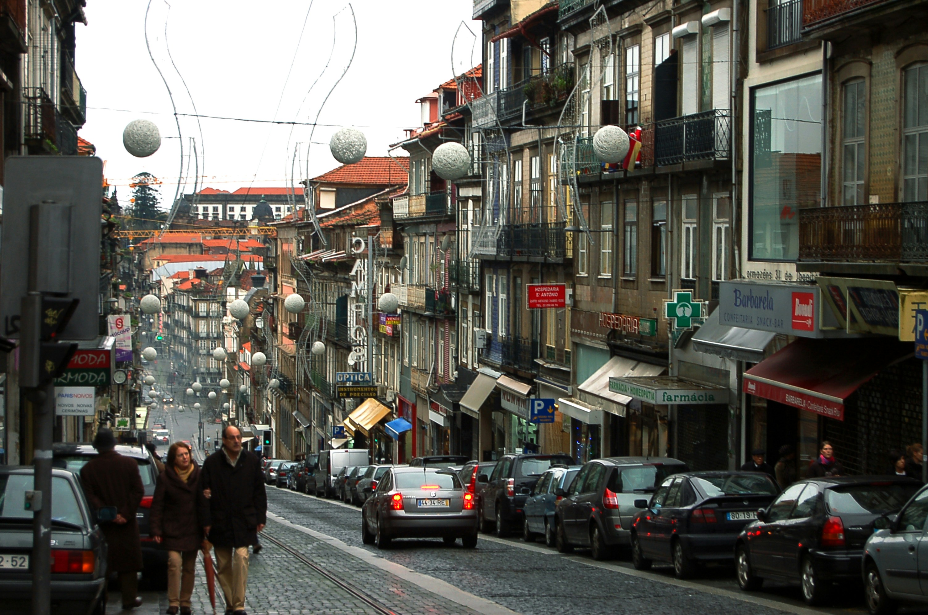 Cobblestone Descent: A Busy Street with Floating Orbs