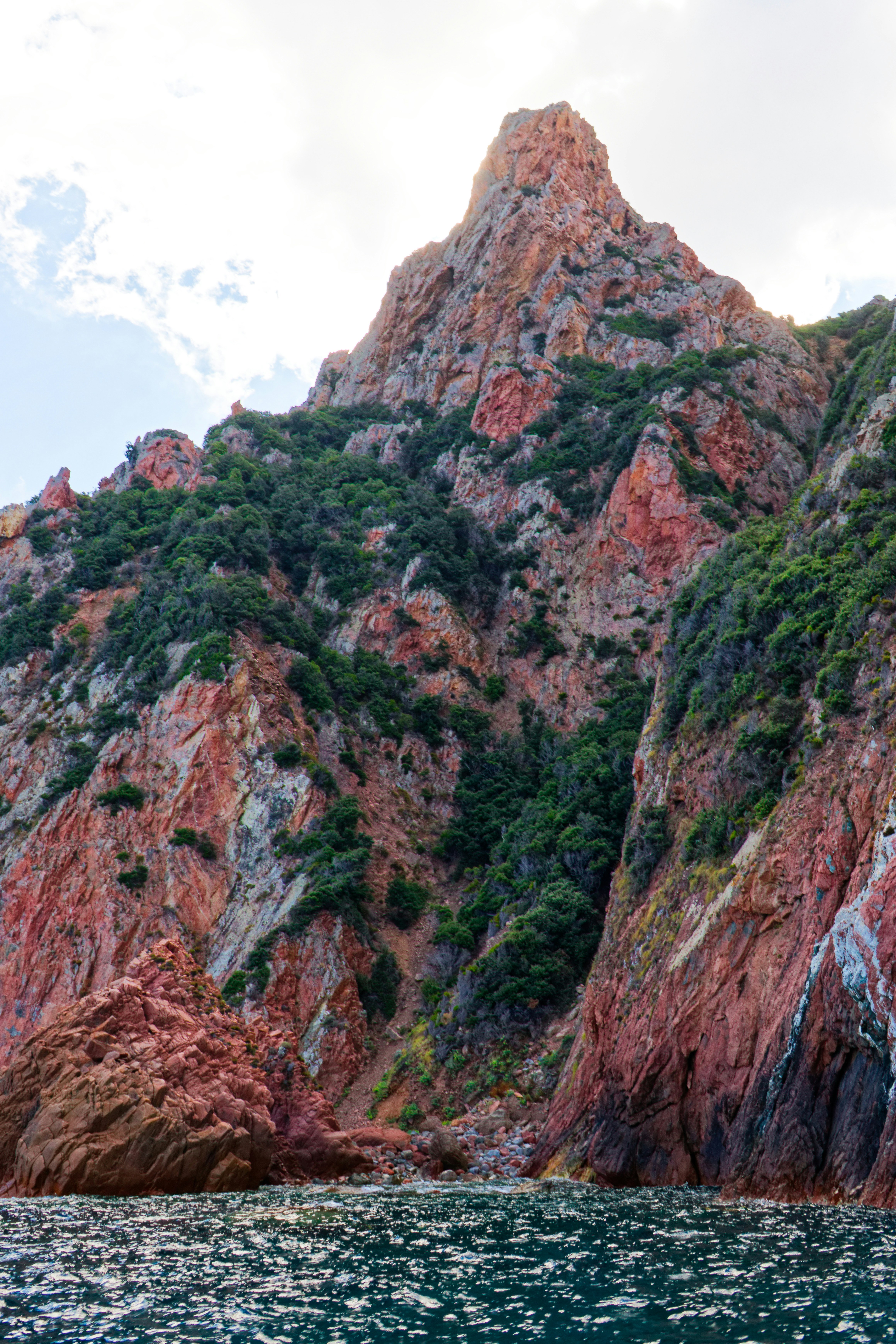 Red Cliff Cathedral Rises: Coastal Peak Painted in Stone