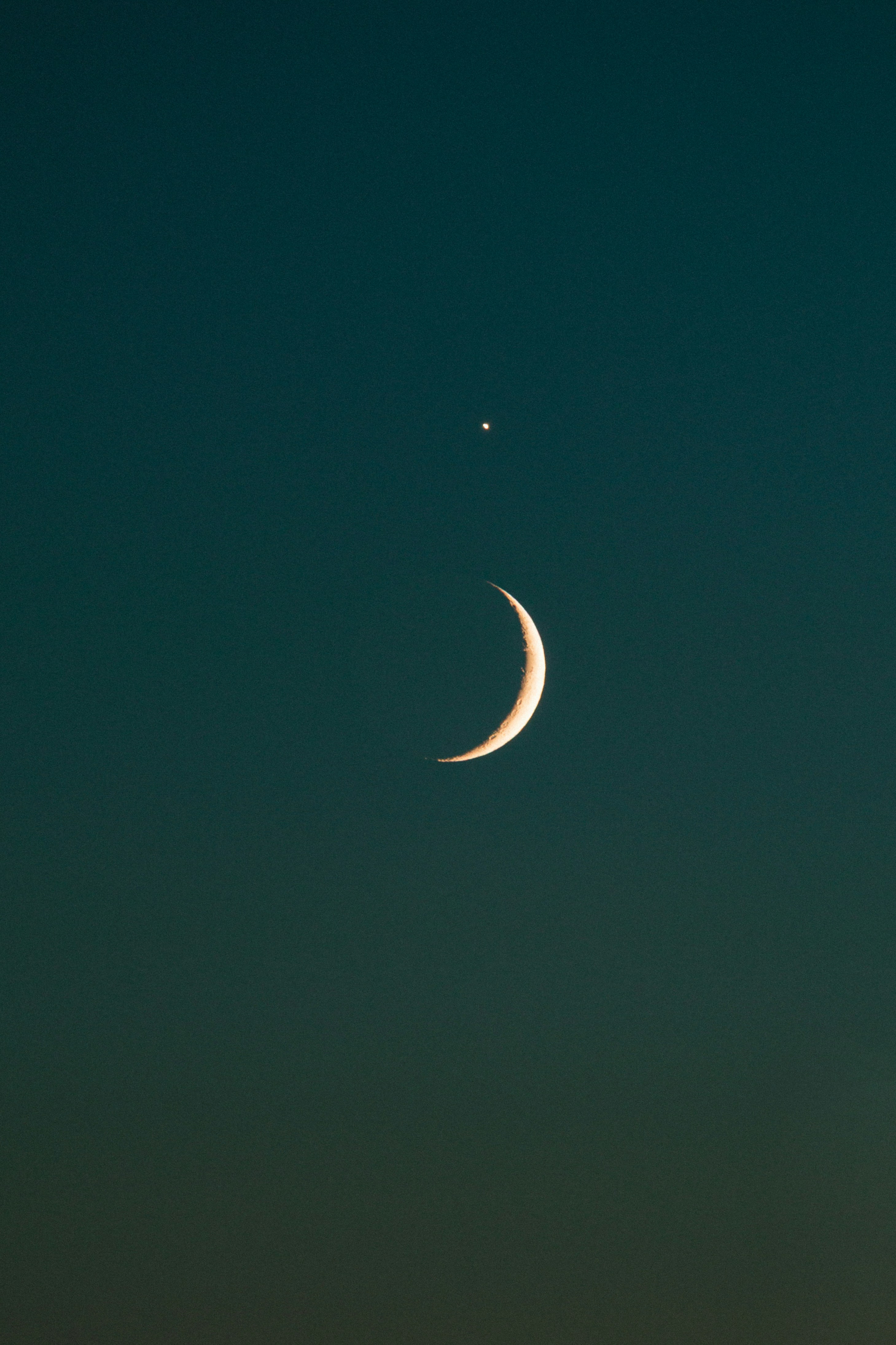 Moonlit Crescent with a Prominent Star