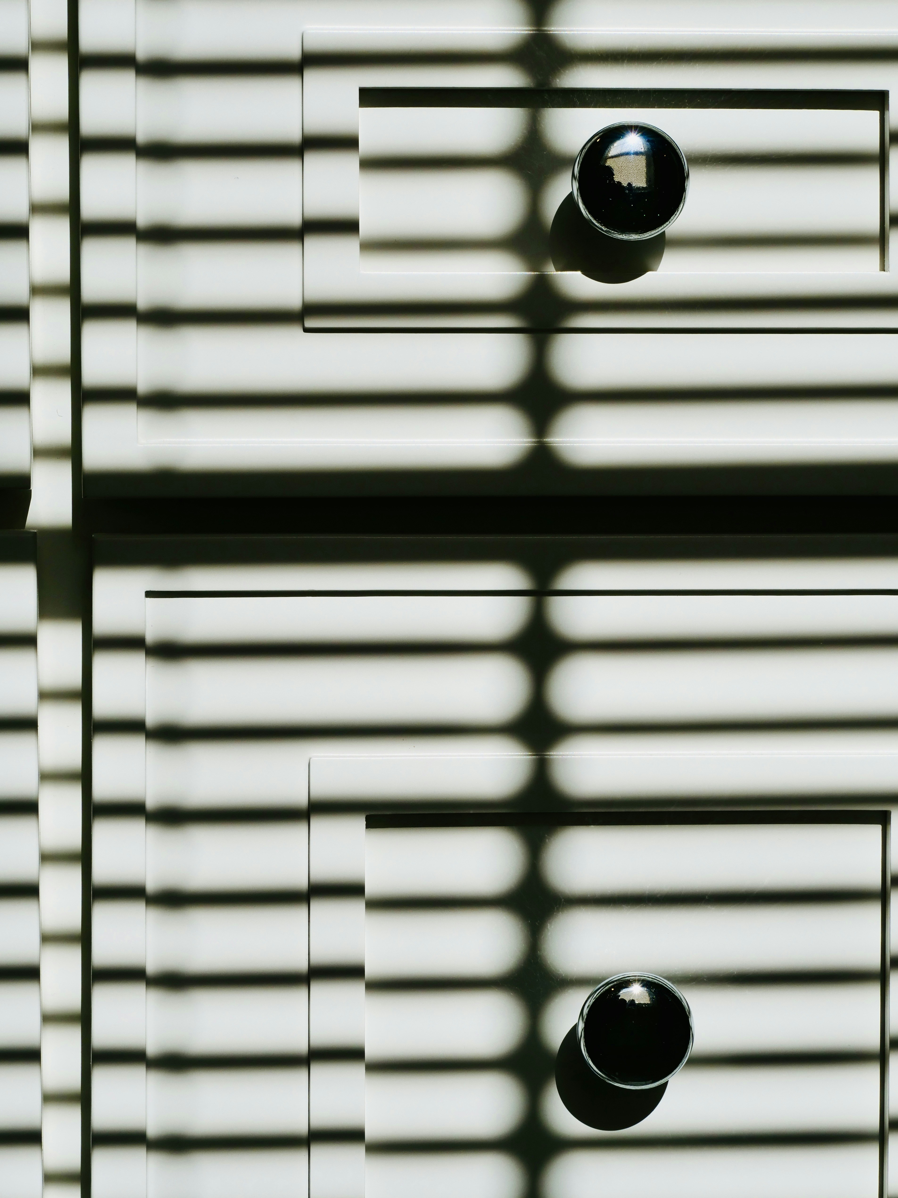 Patterned shadows on a bathroom cupboards
