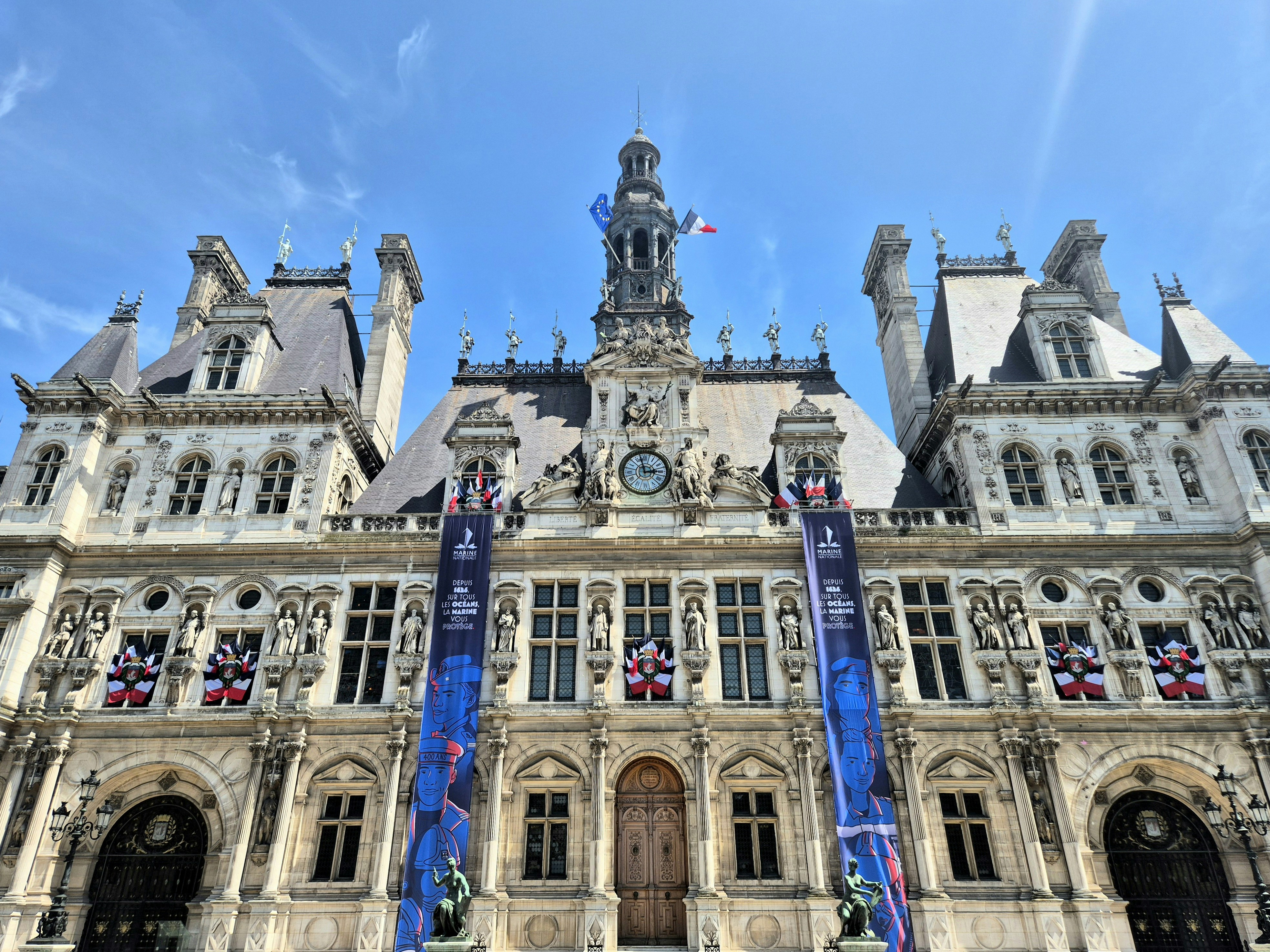Gilded City Hall, Symmetry in Stone and Bannered Facades