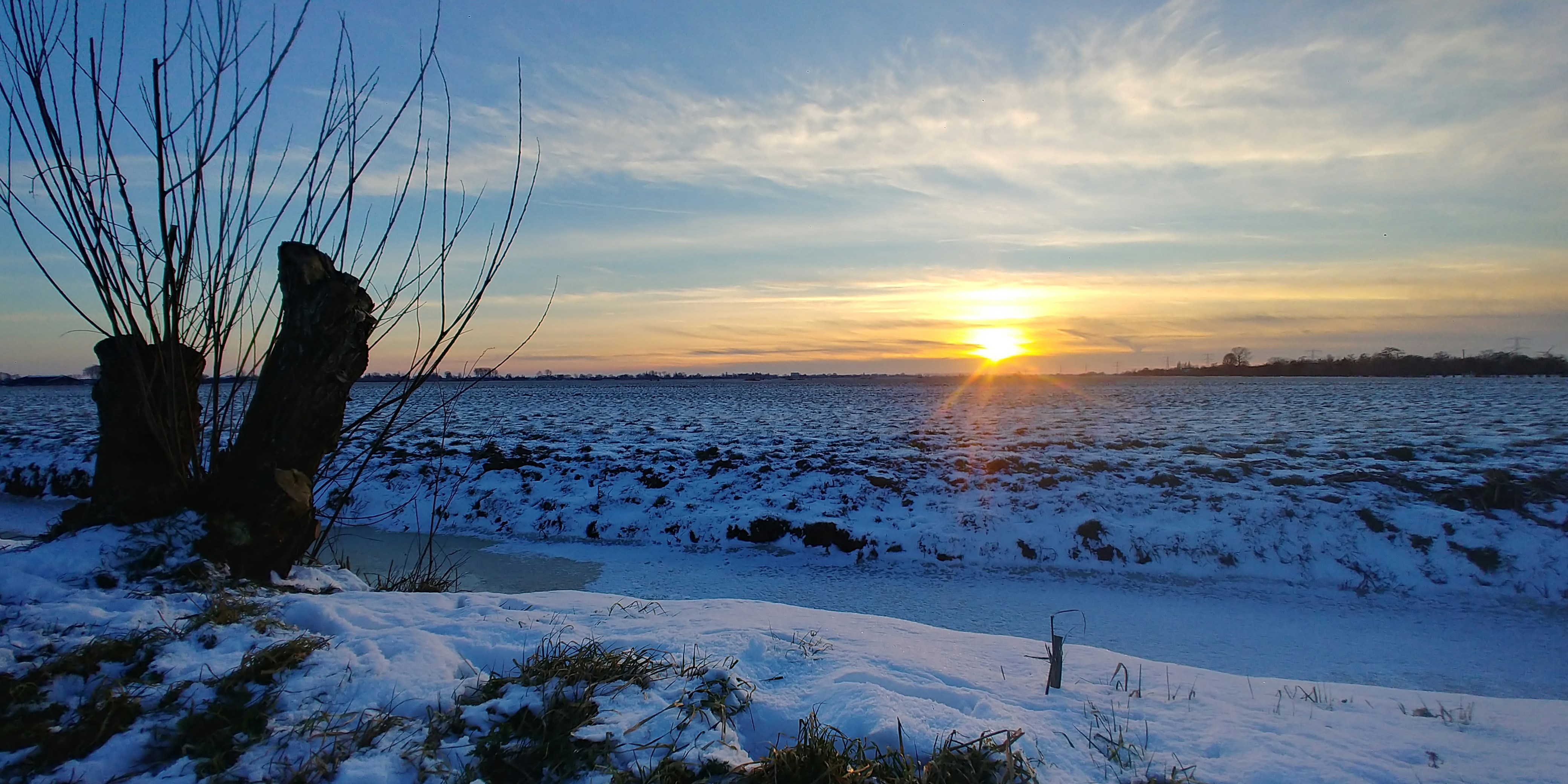 Sunlit Horizon Over a Snowy Field