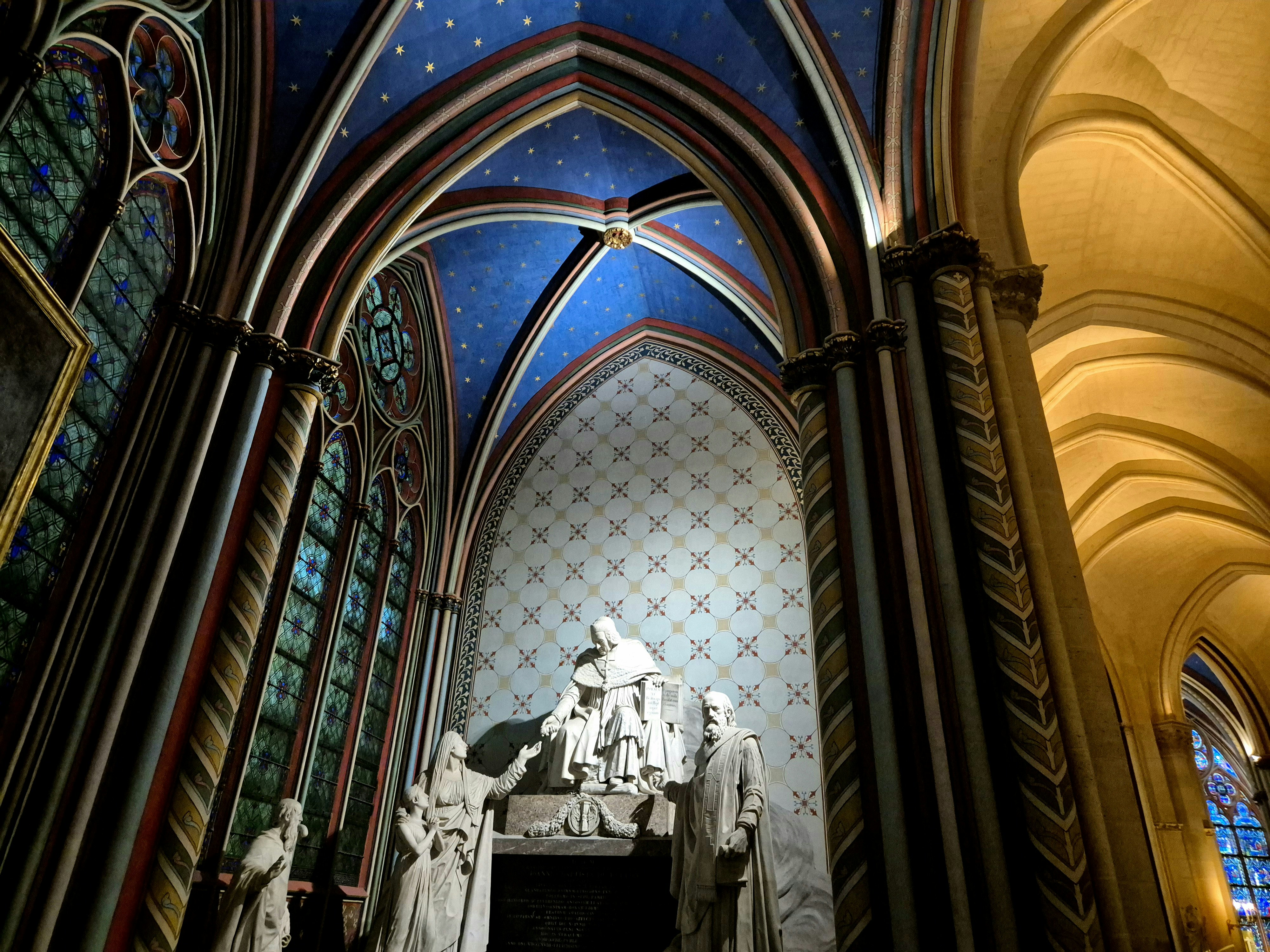 Sculpted Choir Beneath Blues and Gold Arches