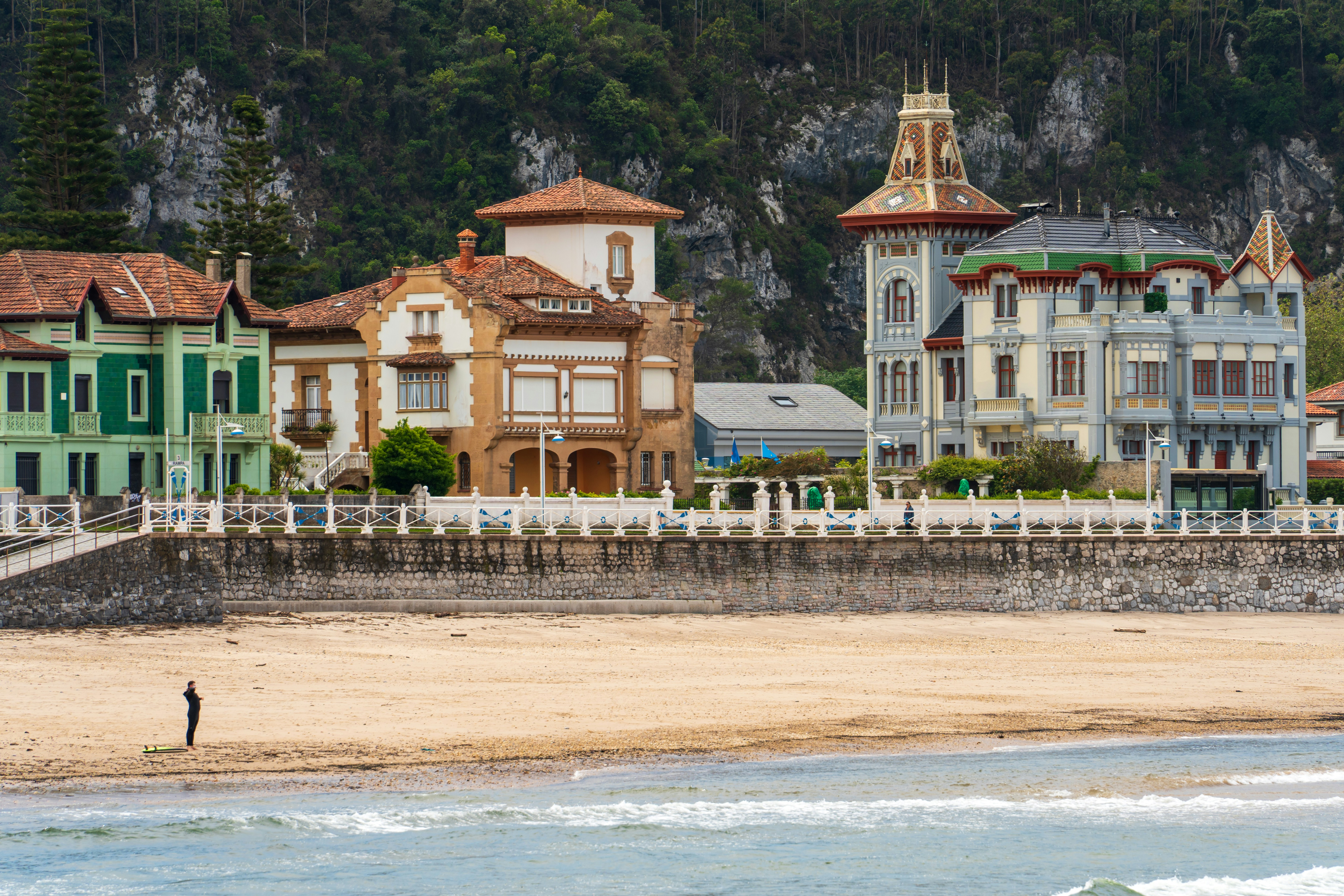 Coastal Row of Facades: A Seaside Village Beneath a Cliff