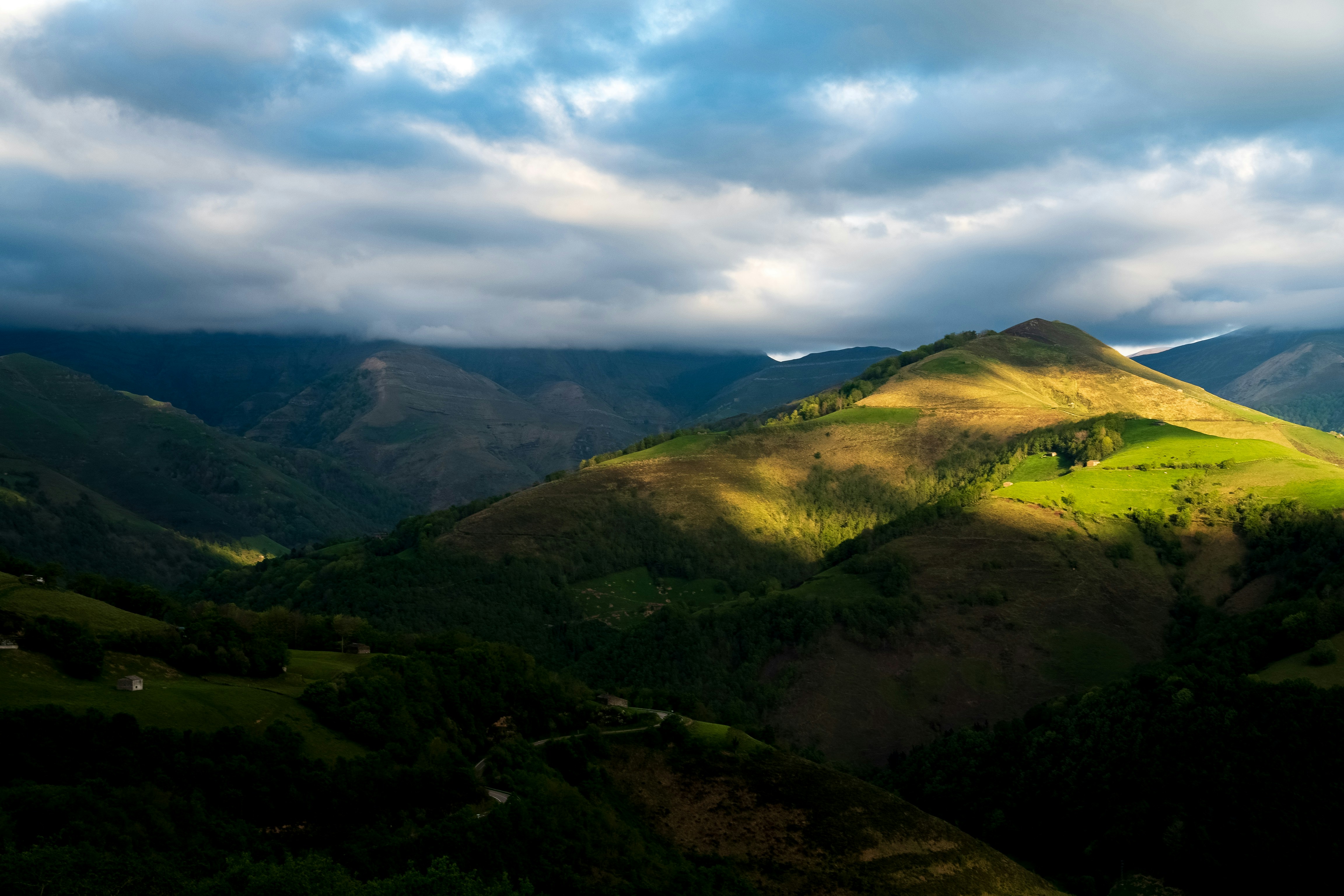 Sunlit Ridge: A Quiet Crest Breaking Through a Clouded Sky