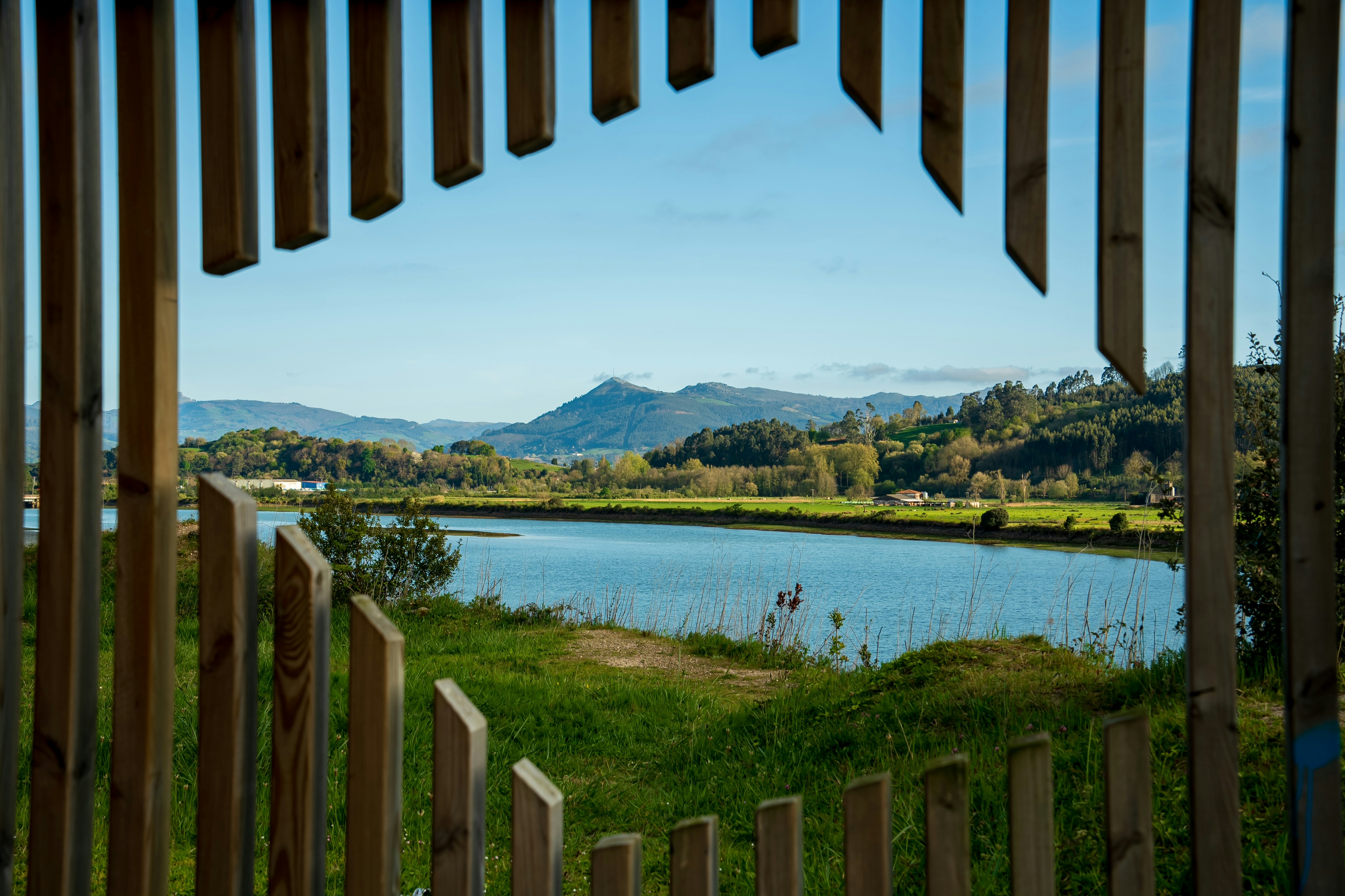 Framing the Landscape: View Through a Wooden Lattice