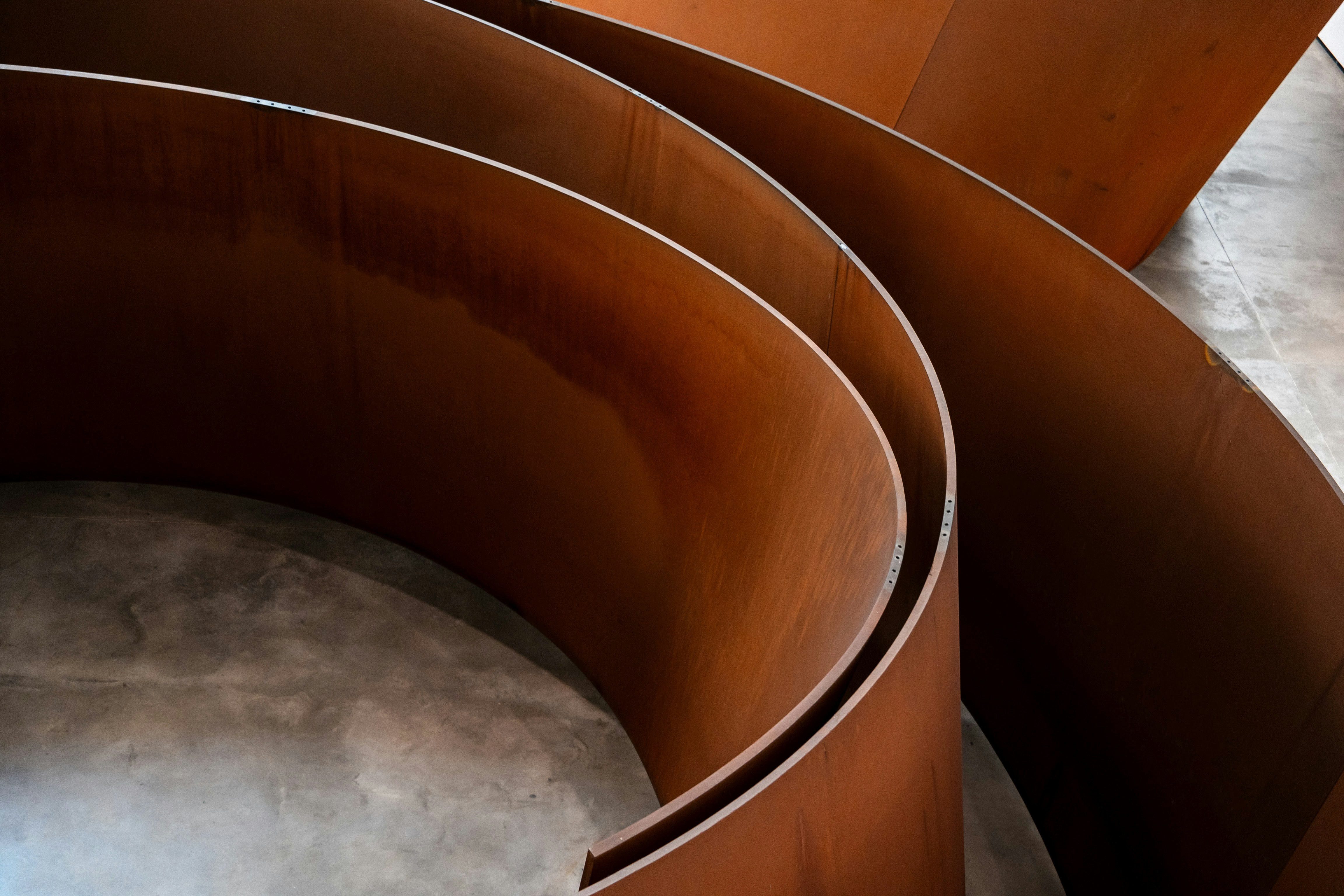 Curved Rust: Abstract Iron Rings Forming a Silent Spiral