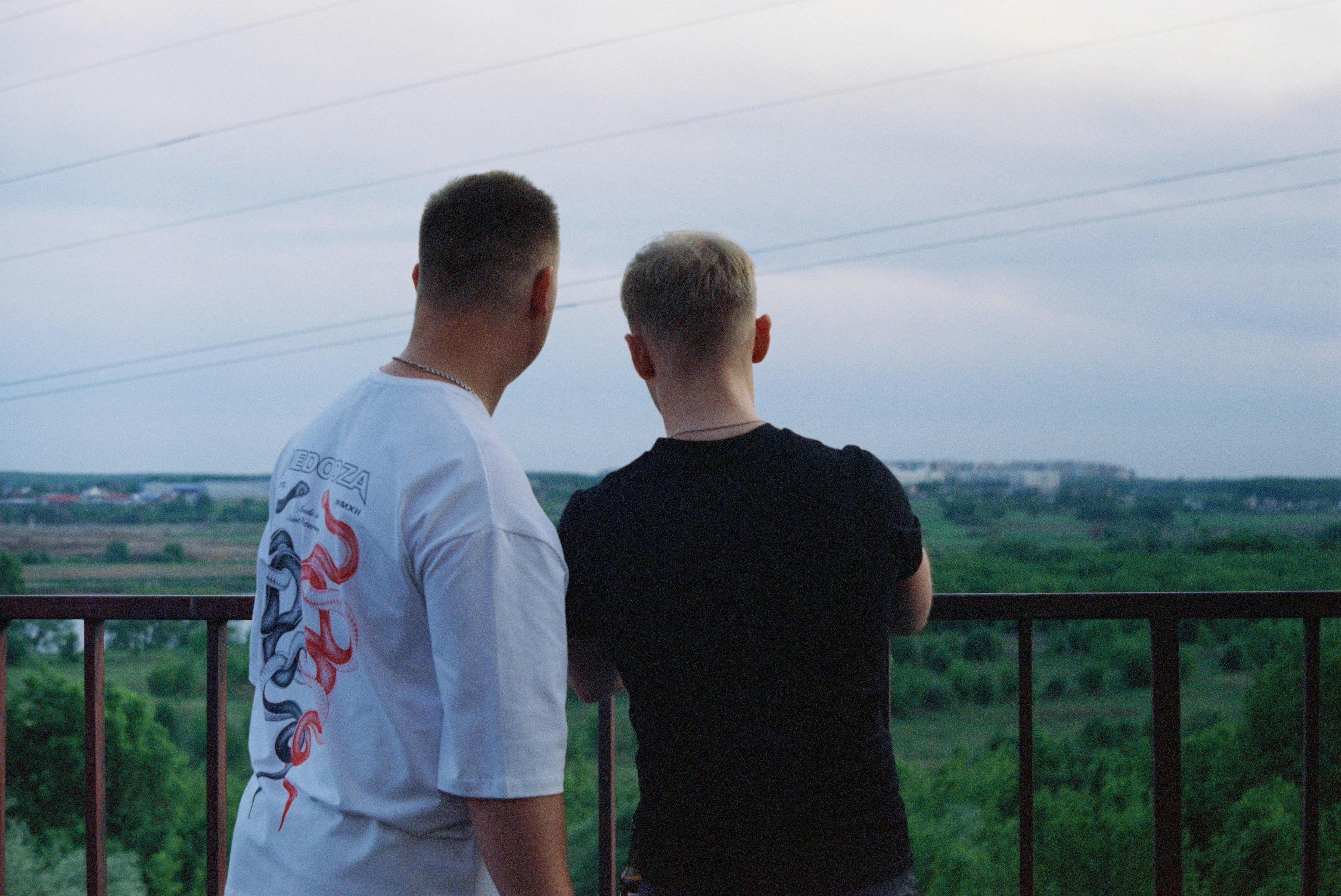 Two Friends on a Sunset-Lilted Balcony