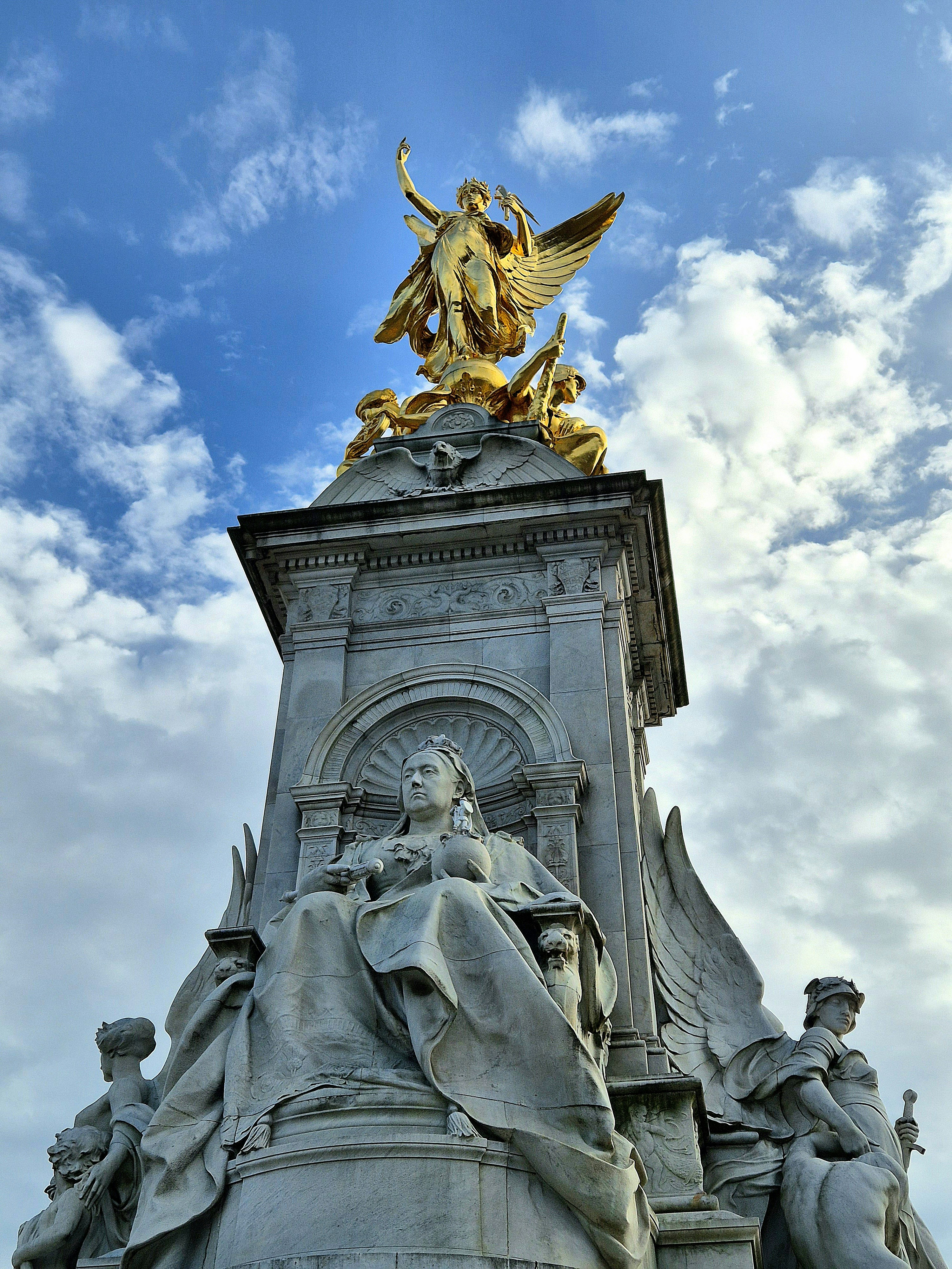Golden Victory Ascends: A Monumental Urn of Statues Under Sky