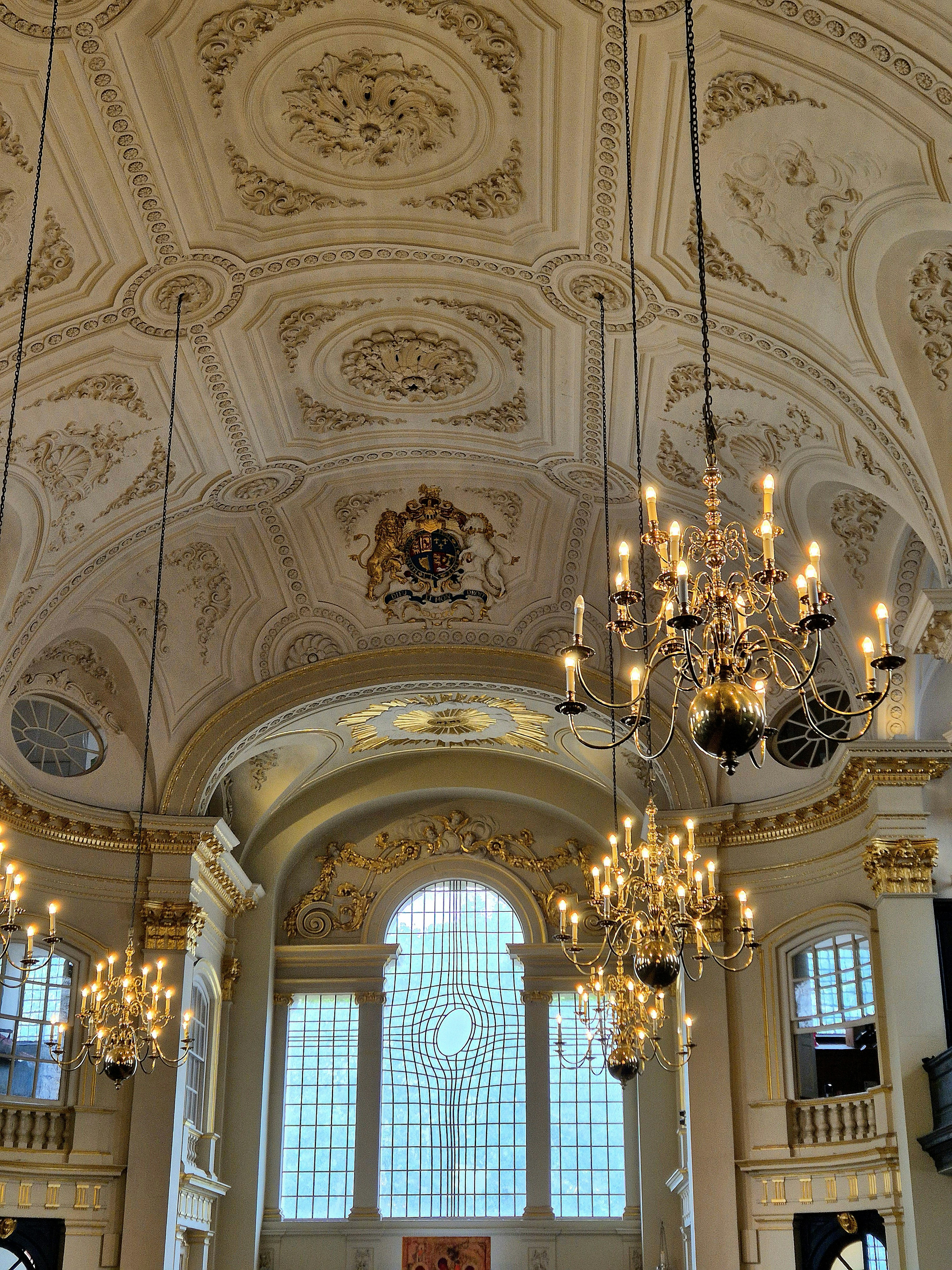 Chandeliered Grandeur: Sunlit Arches Above a Baroque Hall