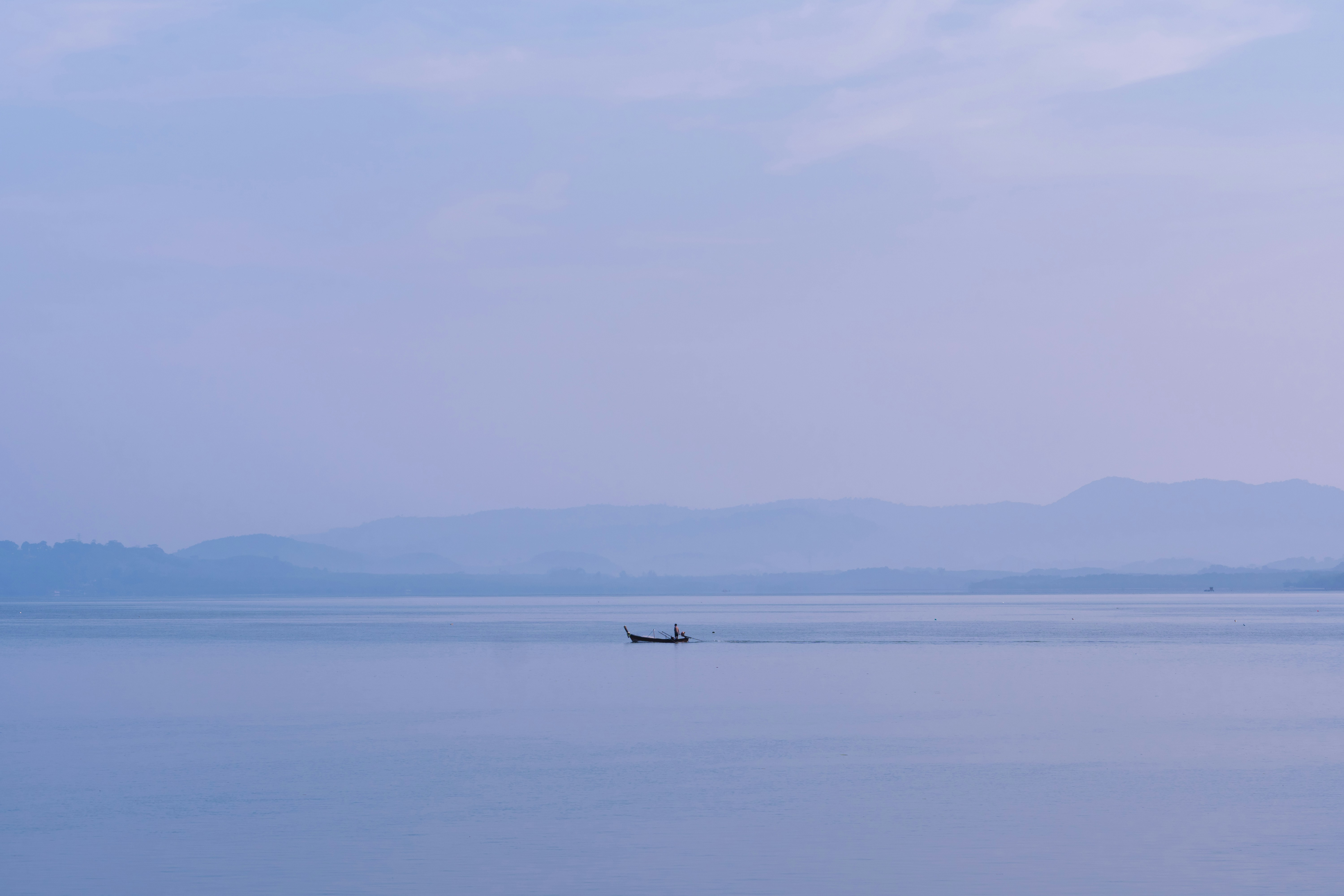Lonely Boat Carves a Misty Horizon