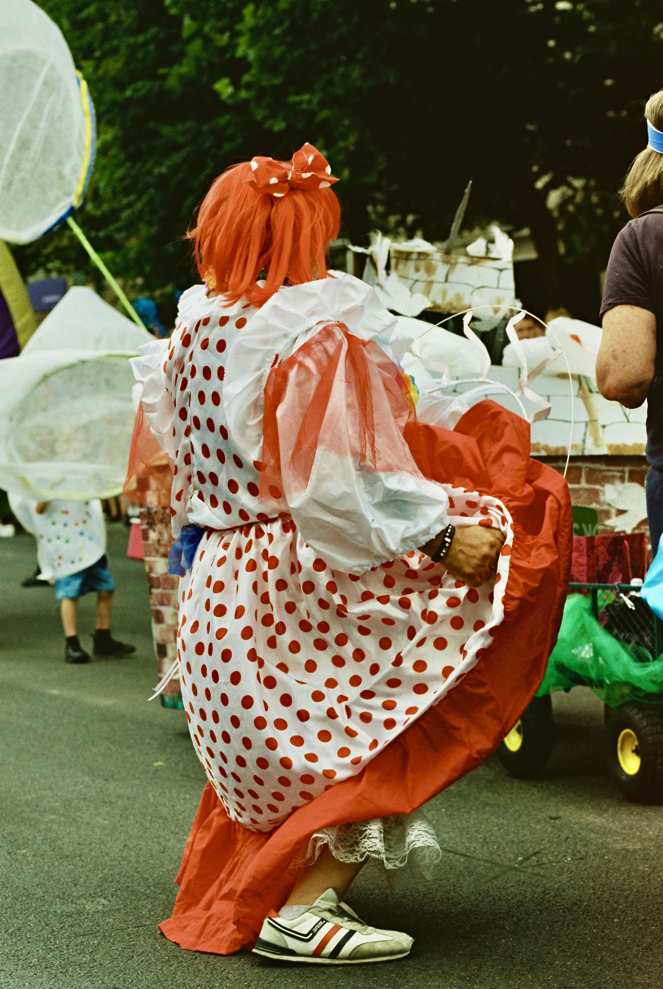 Red-Nosed Ribbon: A Clown in Motion at a Street Fair