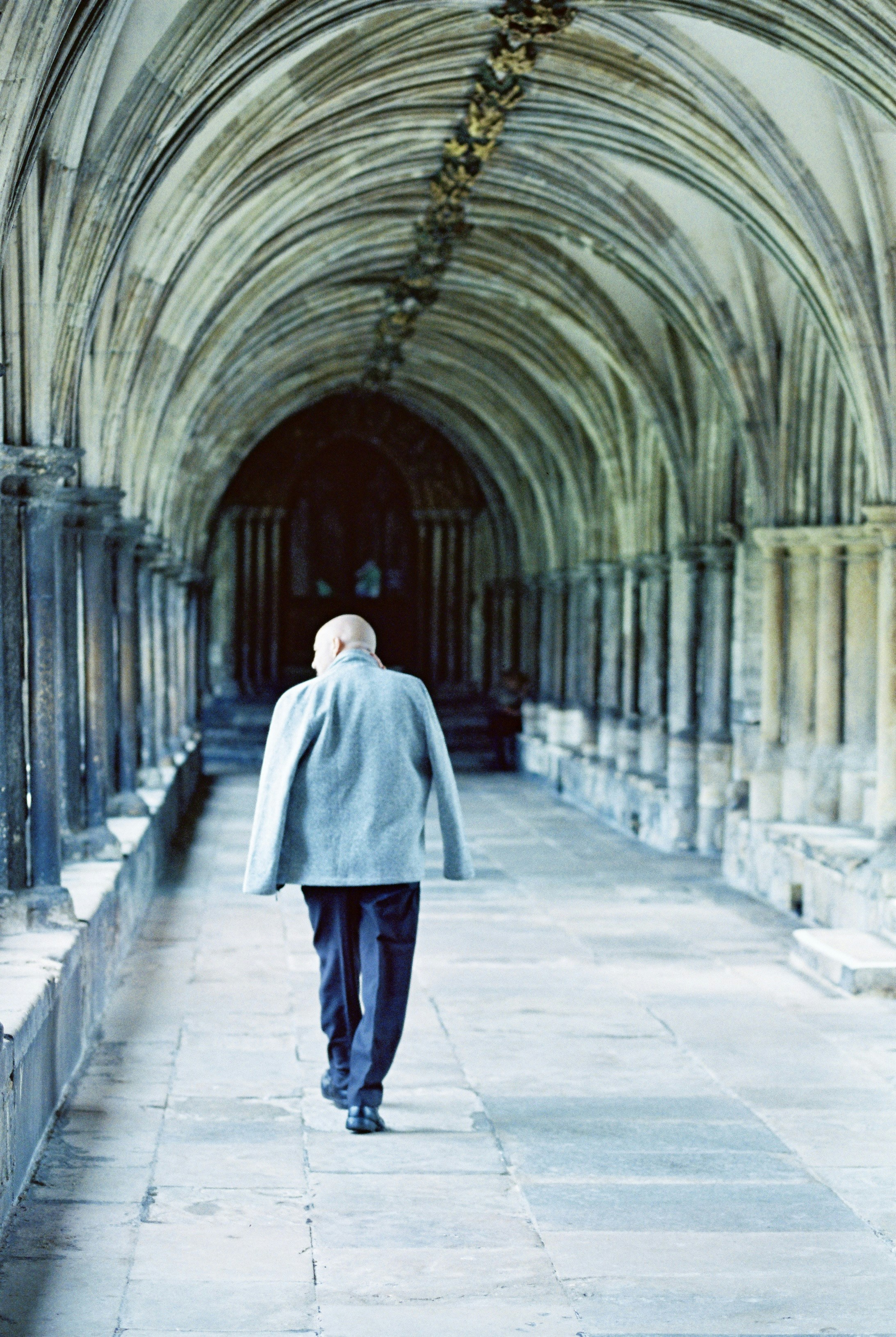 Passage of Memory: A Lone Figure in a Vaulted Cloister