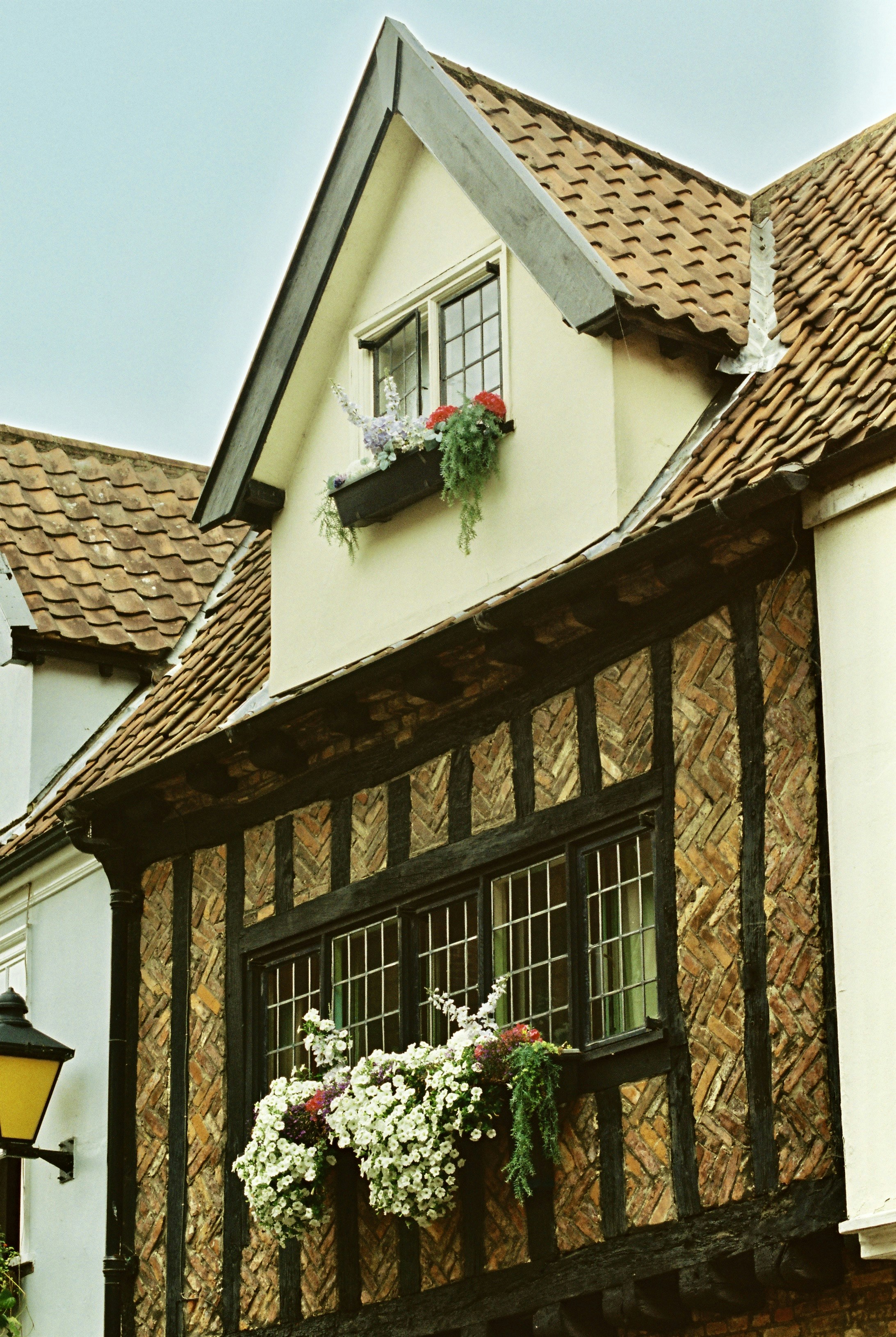 Historic Timber-Framed Facade with Flowered Windowsill