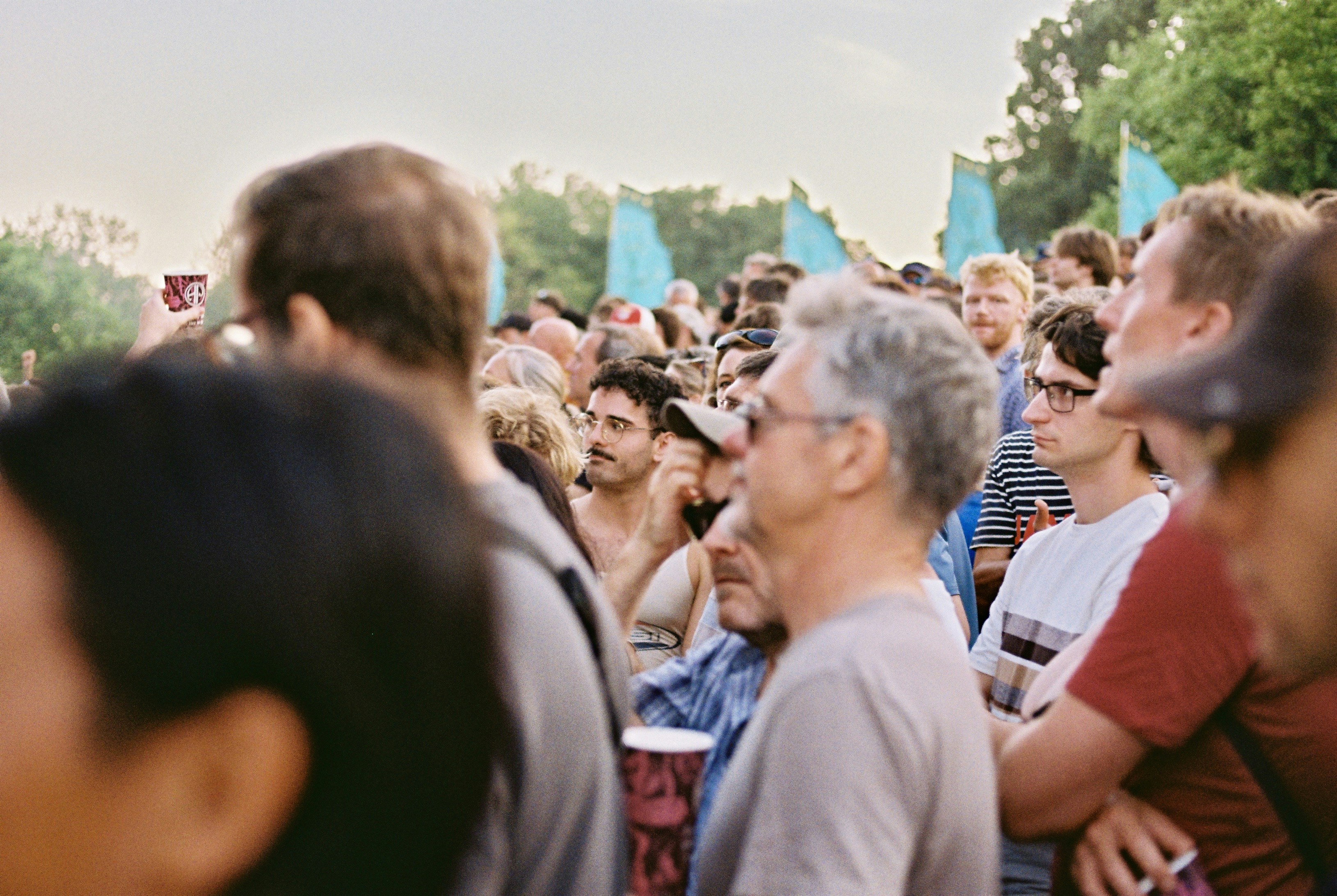 Crowd Pulse: A Sunlit Gathering Where Faces Blur into Motion