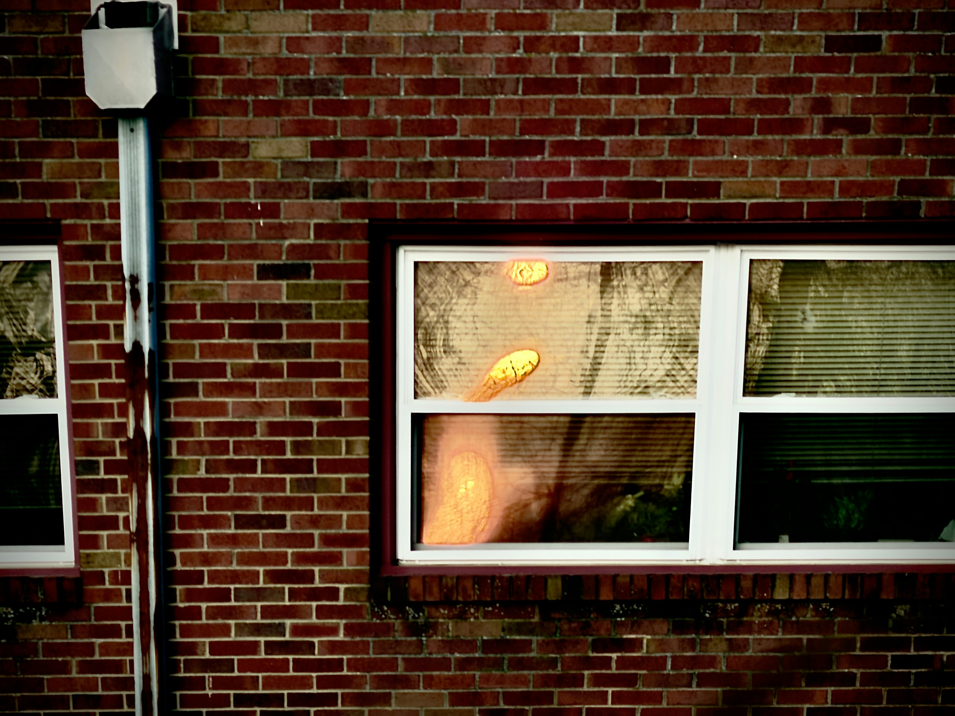 Reflected Glow in a Brick Row House Window