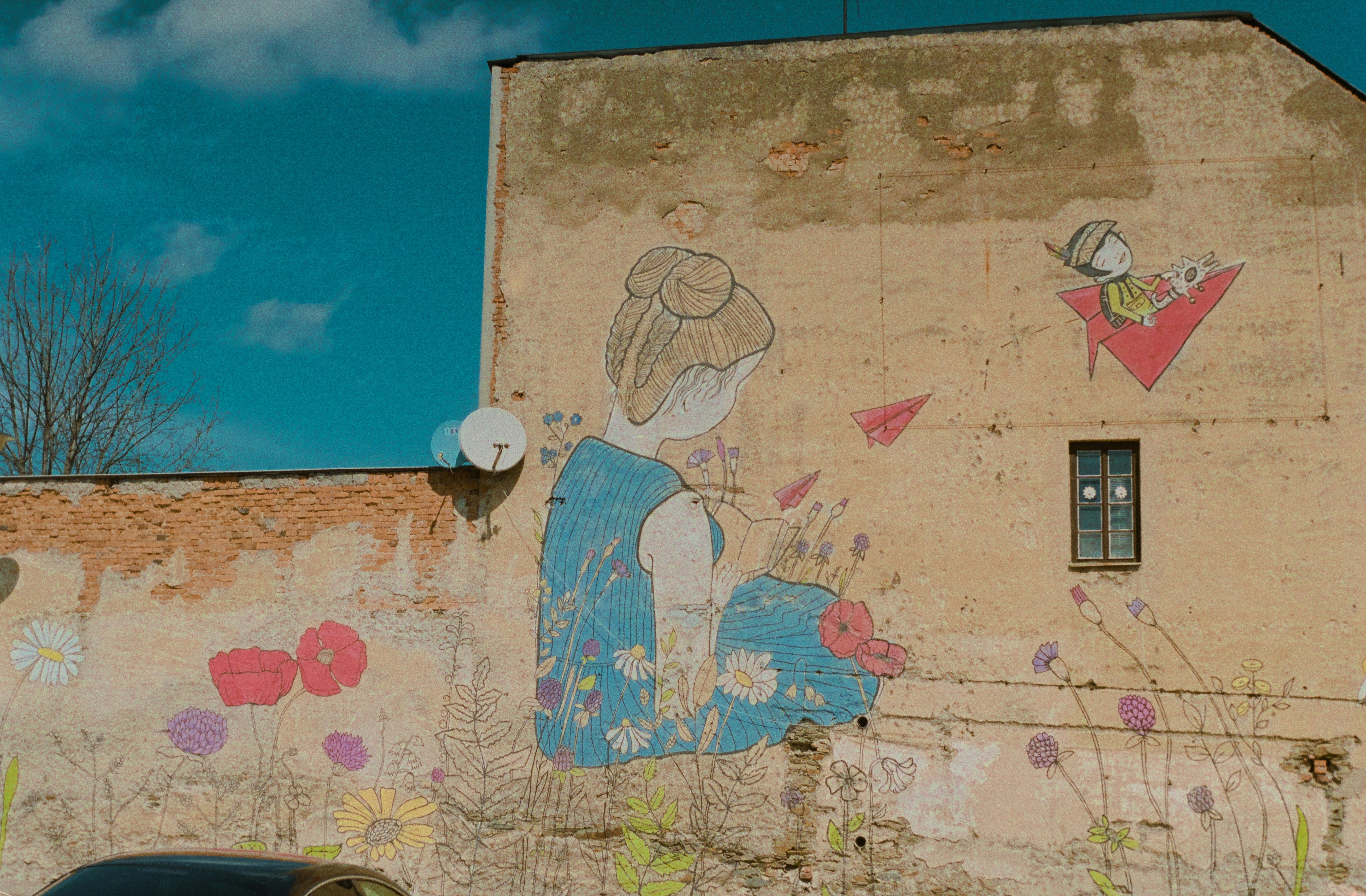 Mural Portrait on Sunlit Brick Wall