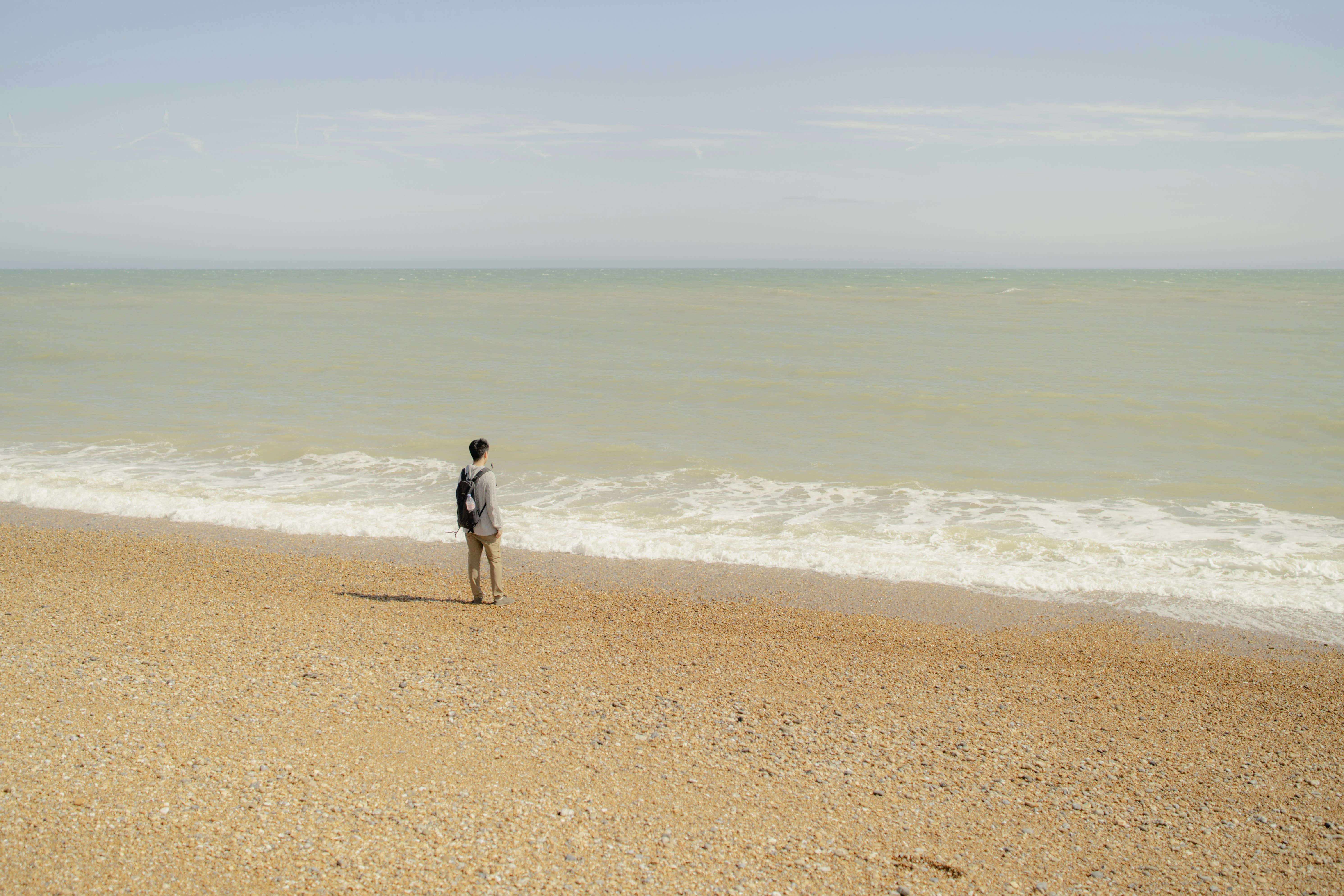 Solitary Walker Along a Quiet Shore