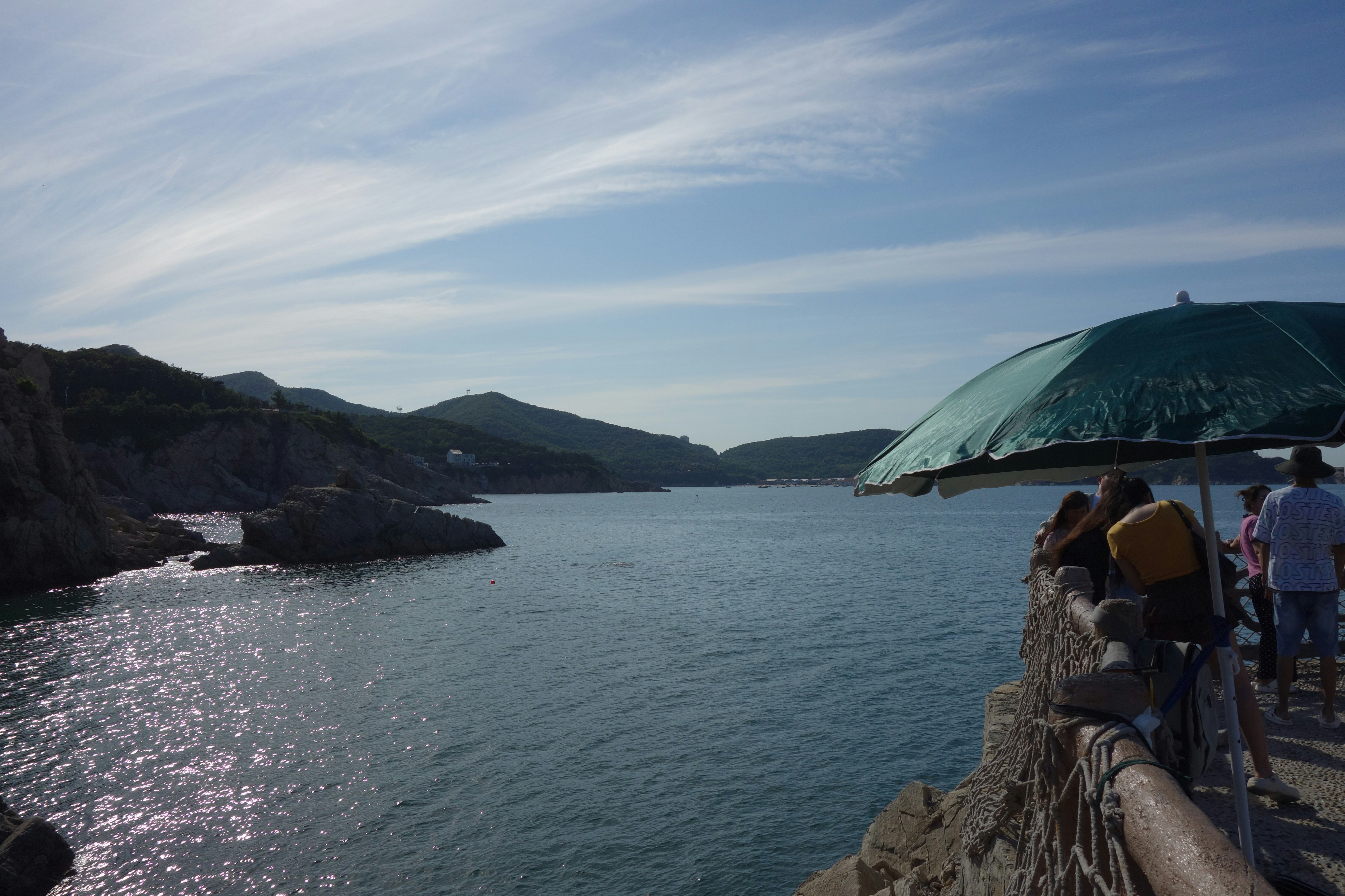 Ridge Walk: Spectators Overlook the Sea as Tide Glistens