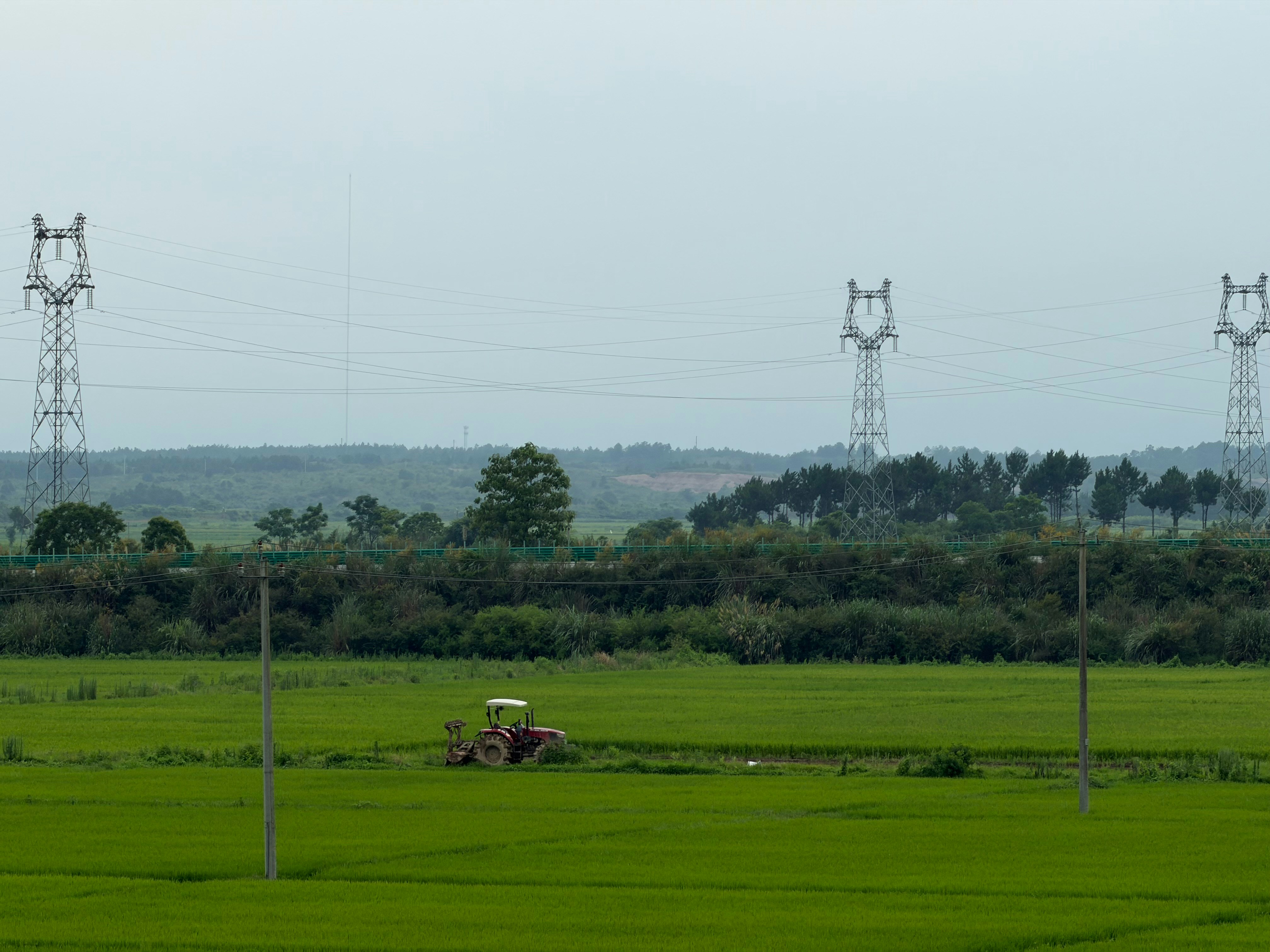 Fields in Quiet Green: Tractor under a Sunlit Sky